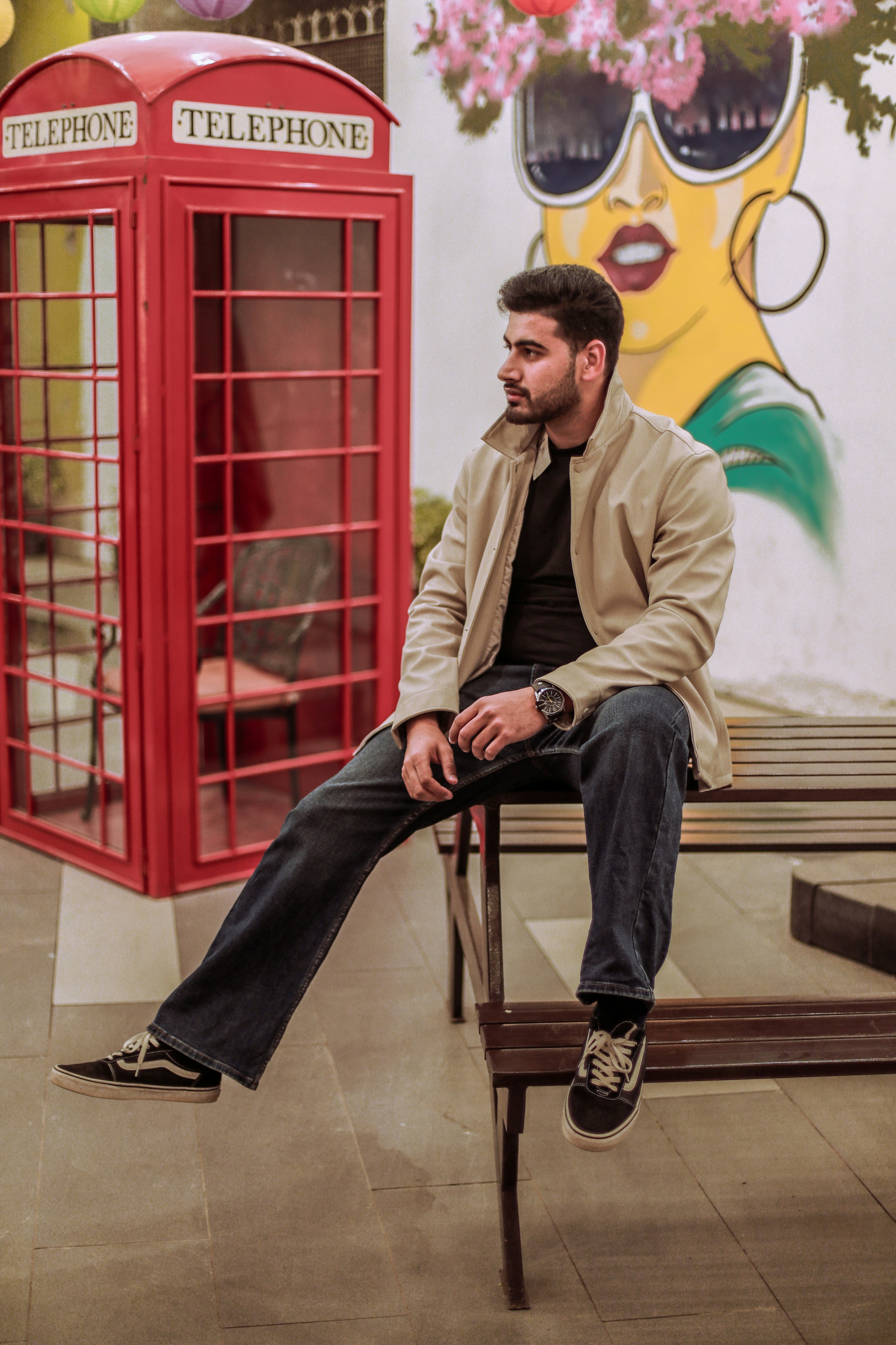 A man sitting on a bench in front of a phone booth photo – Free Sad boy ...
