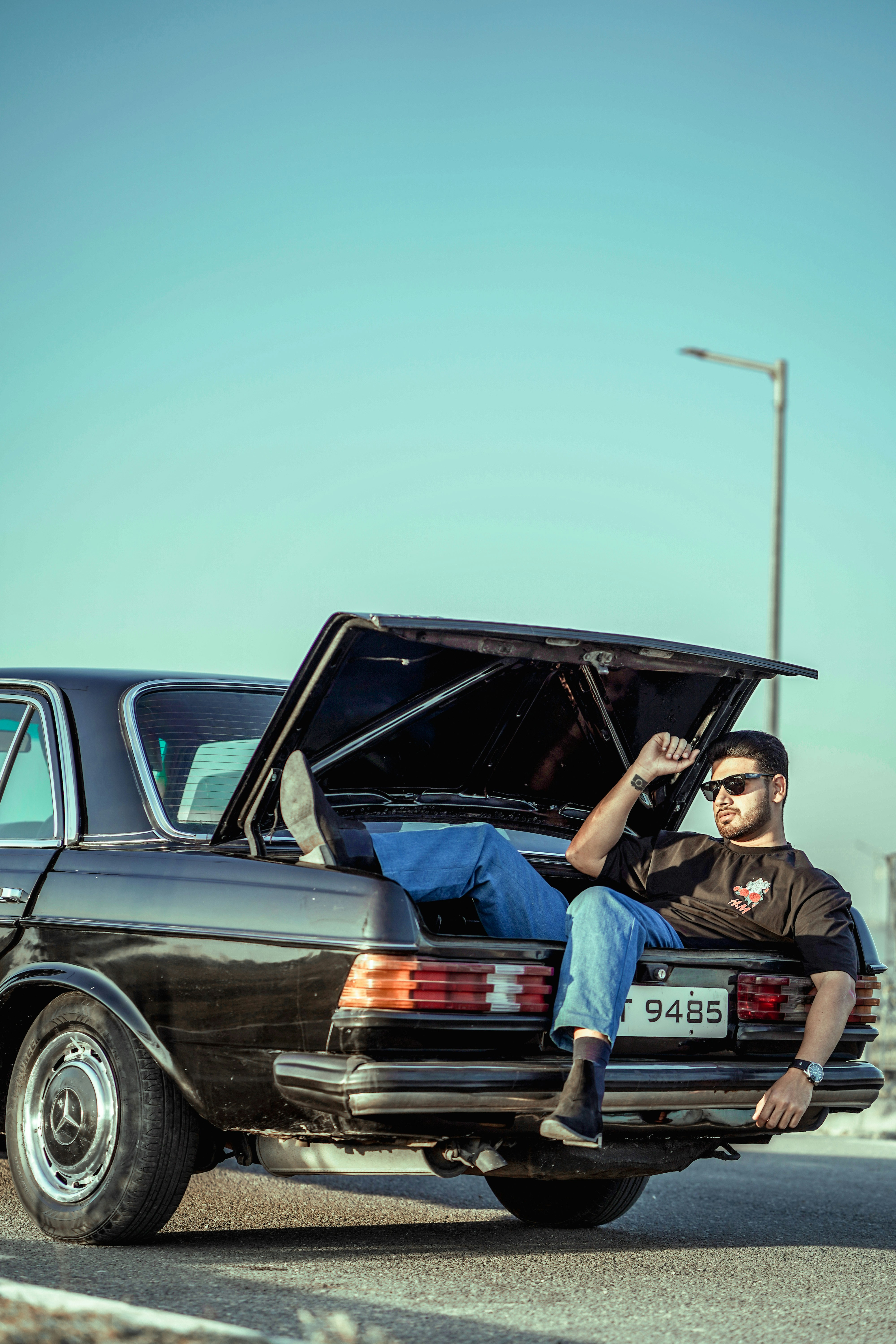 A man sitting in the trunk of a car photo – Free Gangster Image on Unsplash