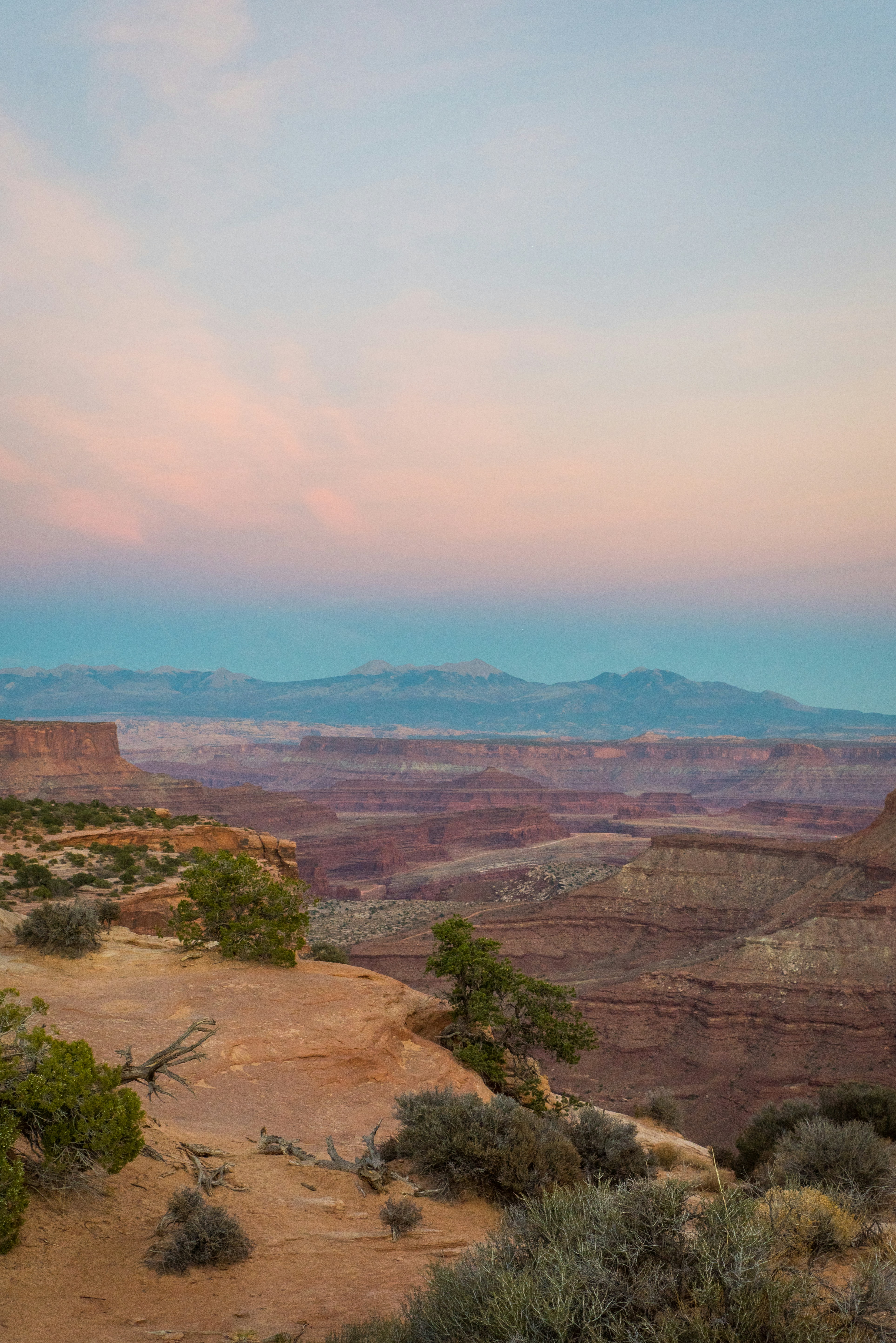Desert Rim at Dusk: Carved Horizons and Soft Sunrise Hues