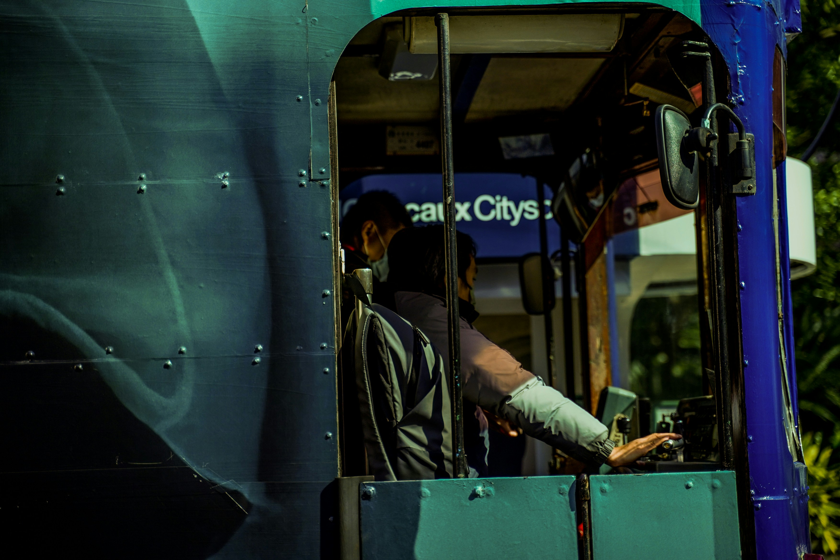 Hands at the Window: A Quiet Moment Inside a City Bus Cab