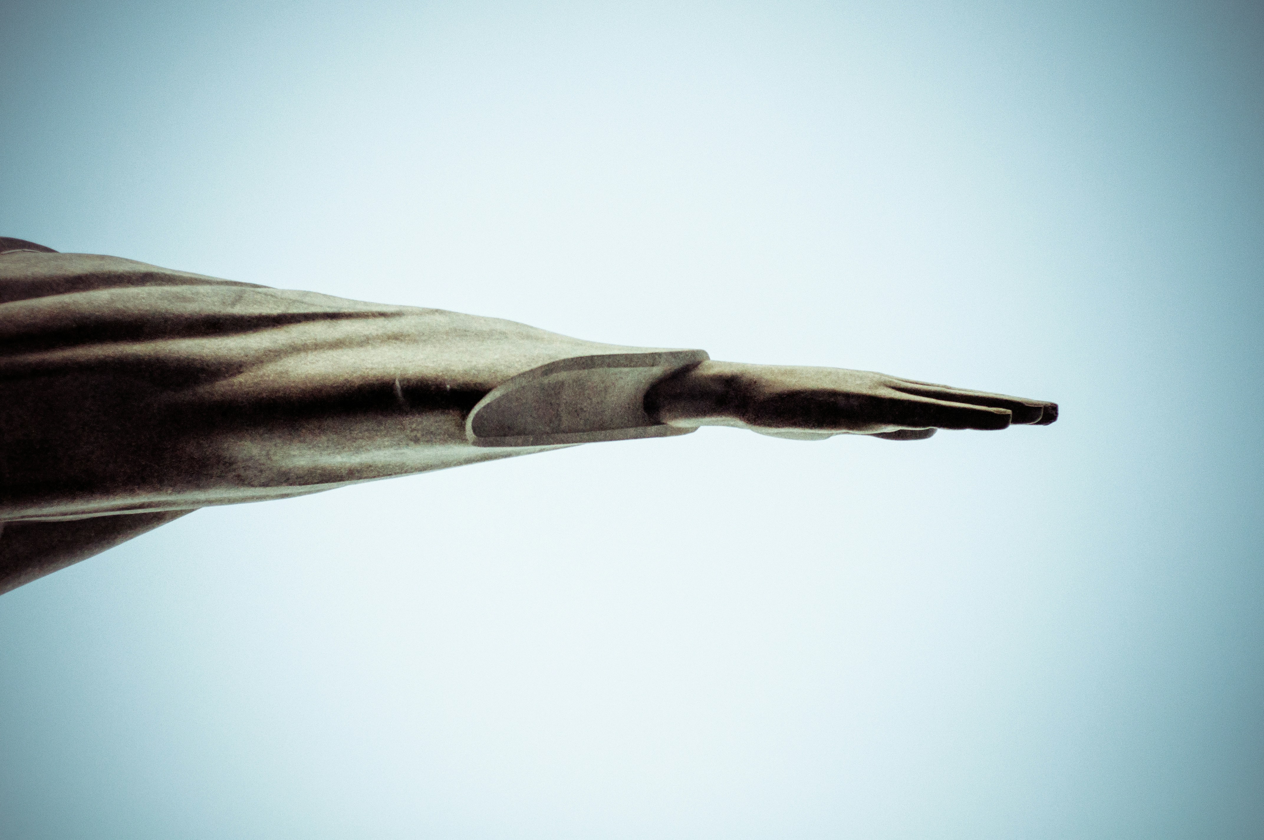 A statue of a hand reaching up into the sky photo – Free Rio de janeiro ...