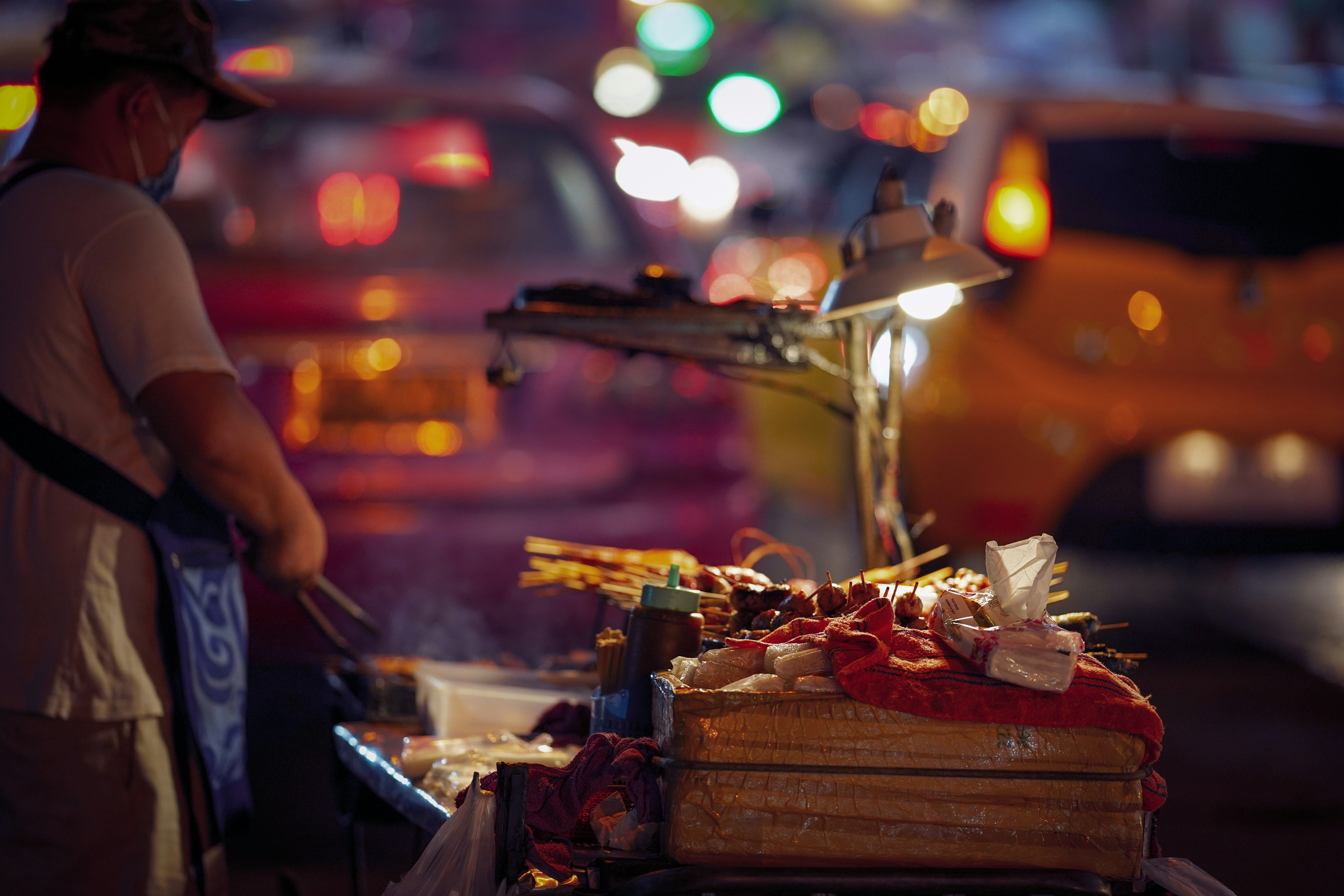 Night Street Skewers: Warm Light Amid Neon Traffic