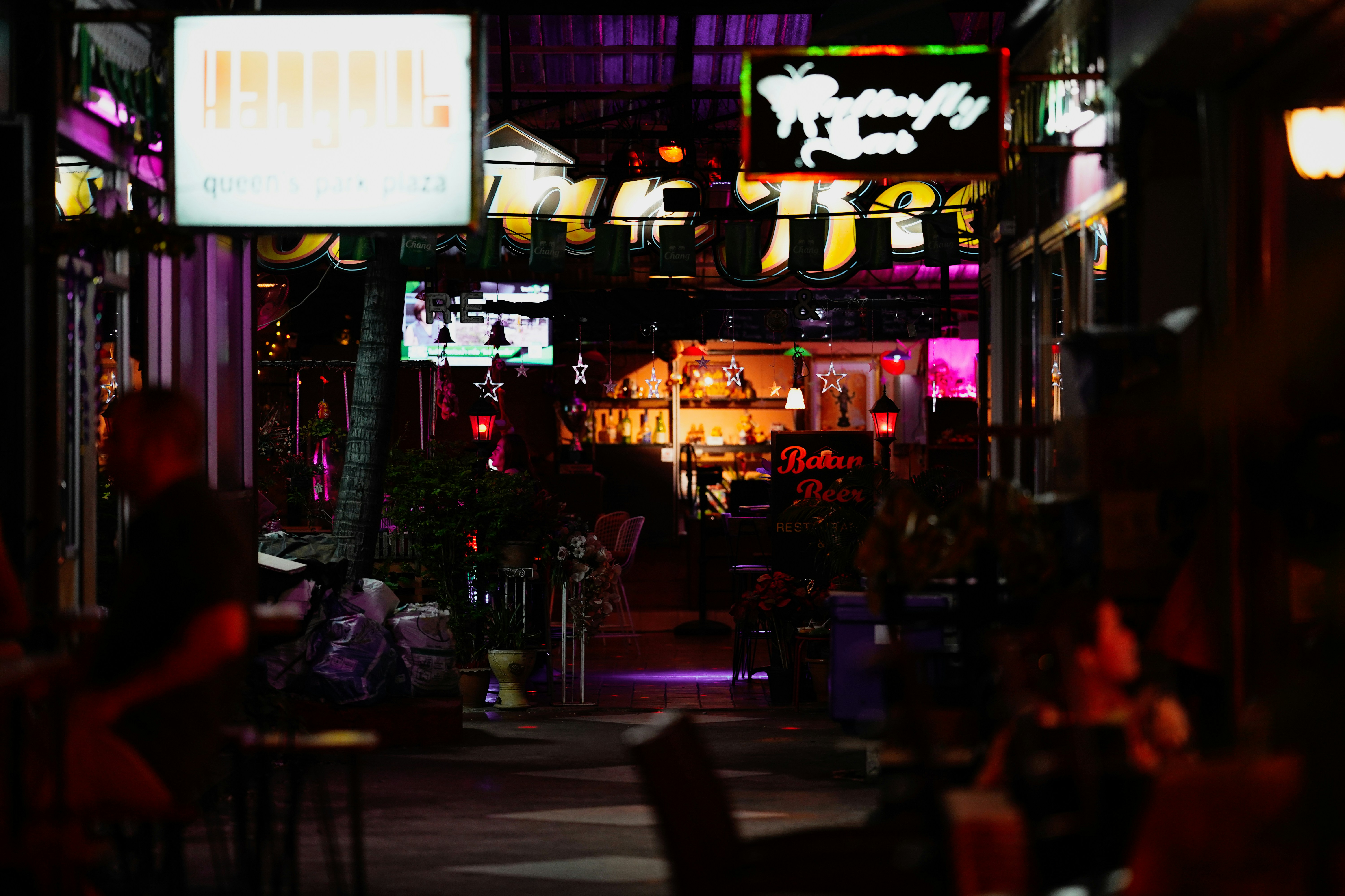 A dark street at night with neon signs photo – Free Night club Image on ...