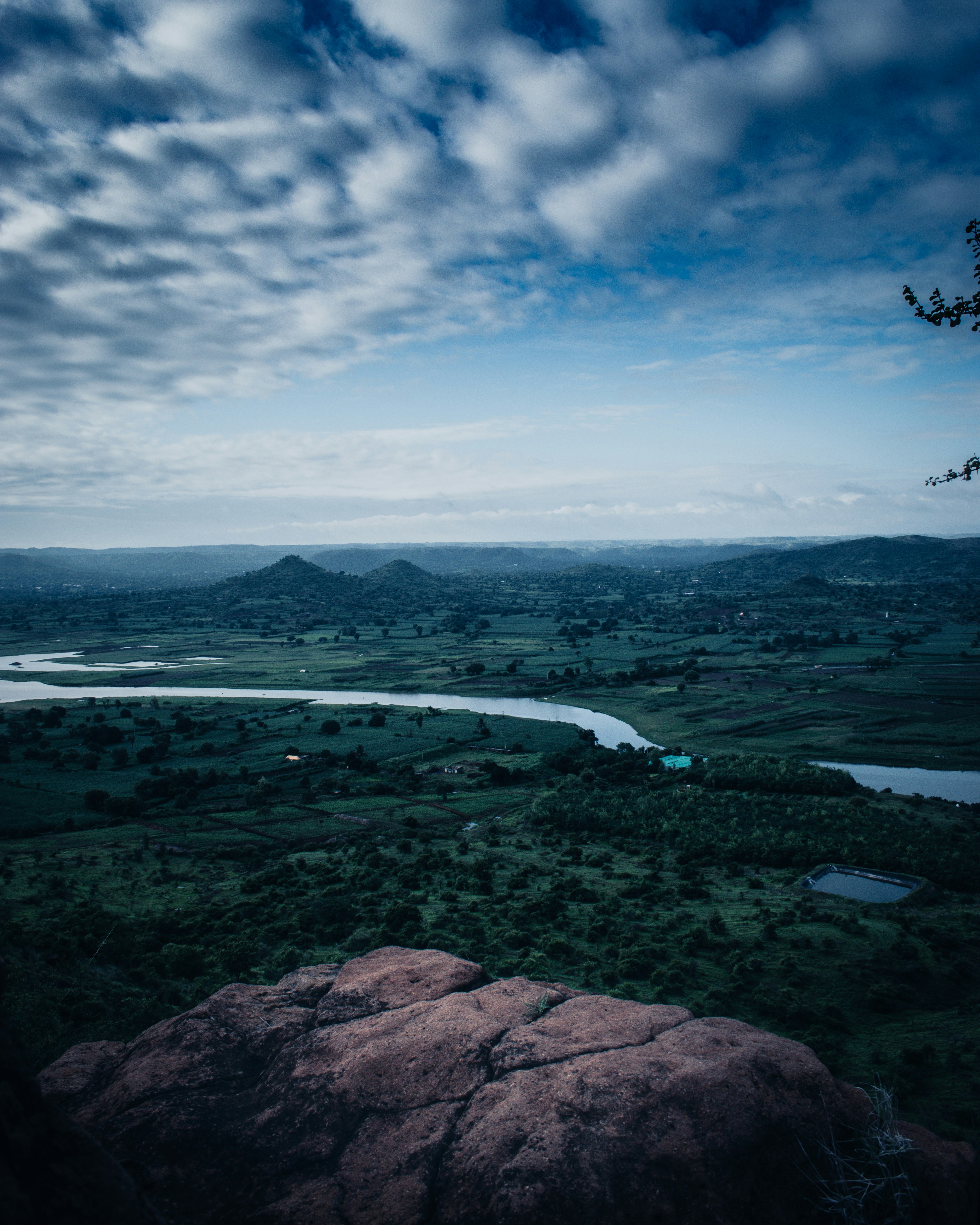 Ridge Overlook: A Valley Unfolds Beneath Sky-Crafted Clouds