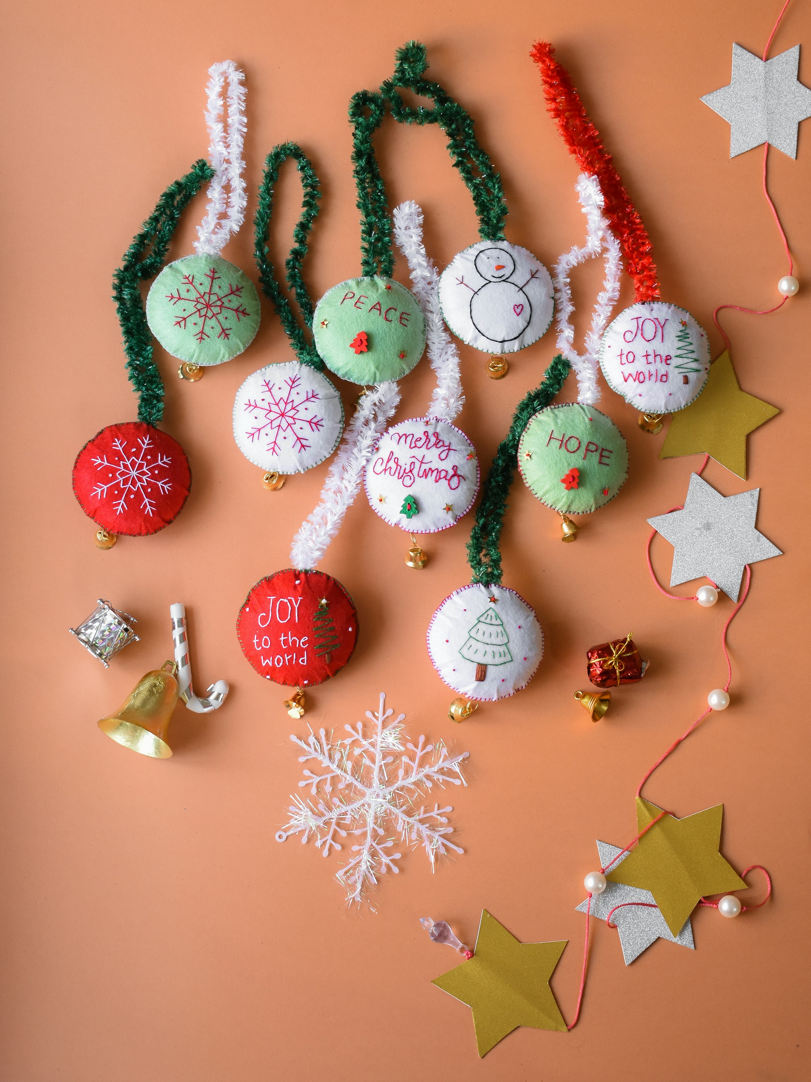 a collection of christmas ornaments on a pink background