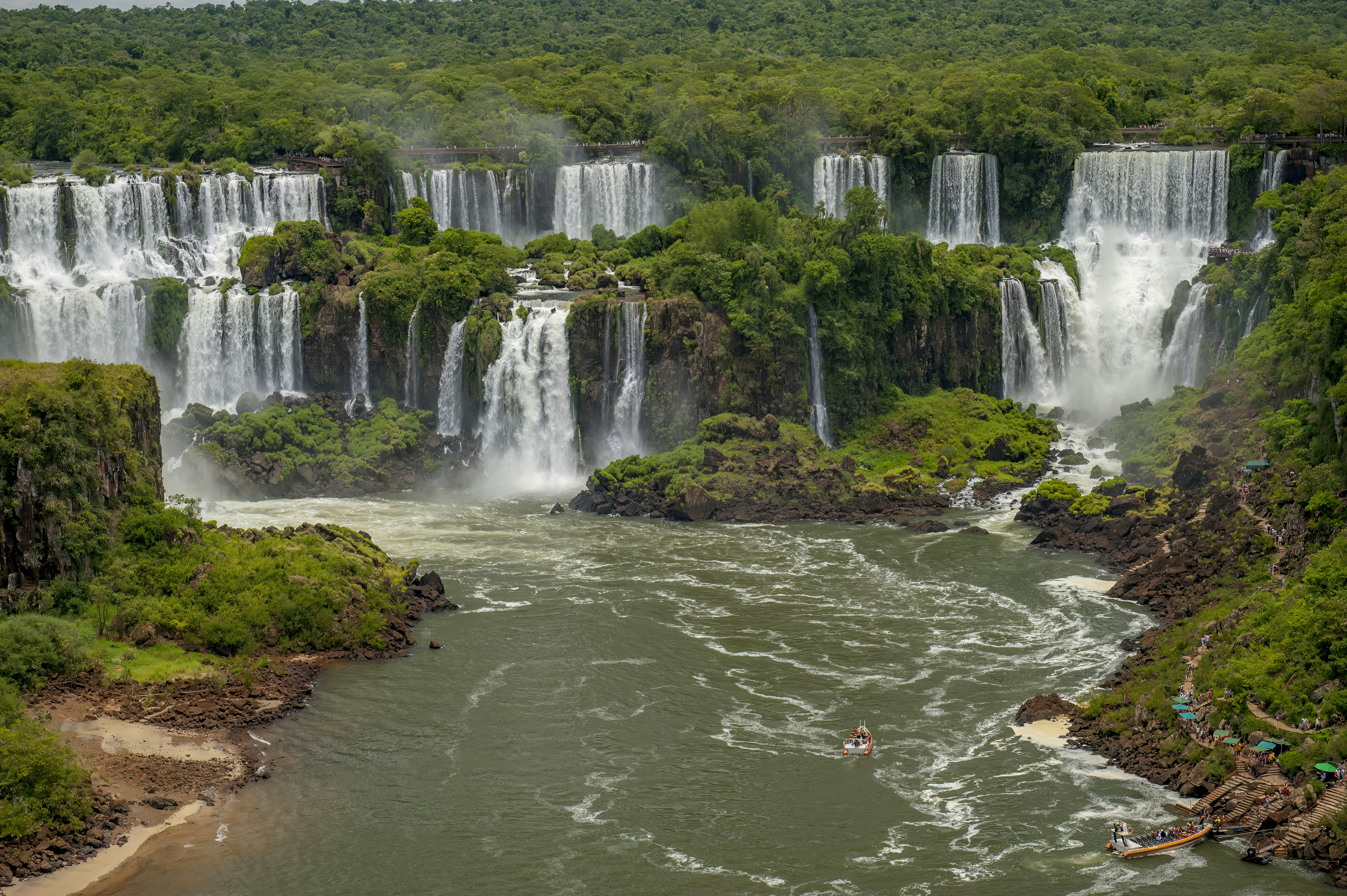A large waterfall with a boat in the middle of it photo – Free Nature ...