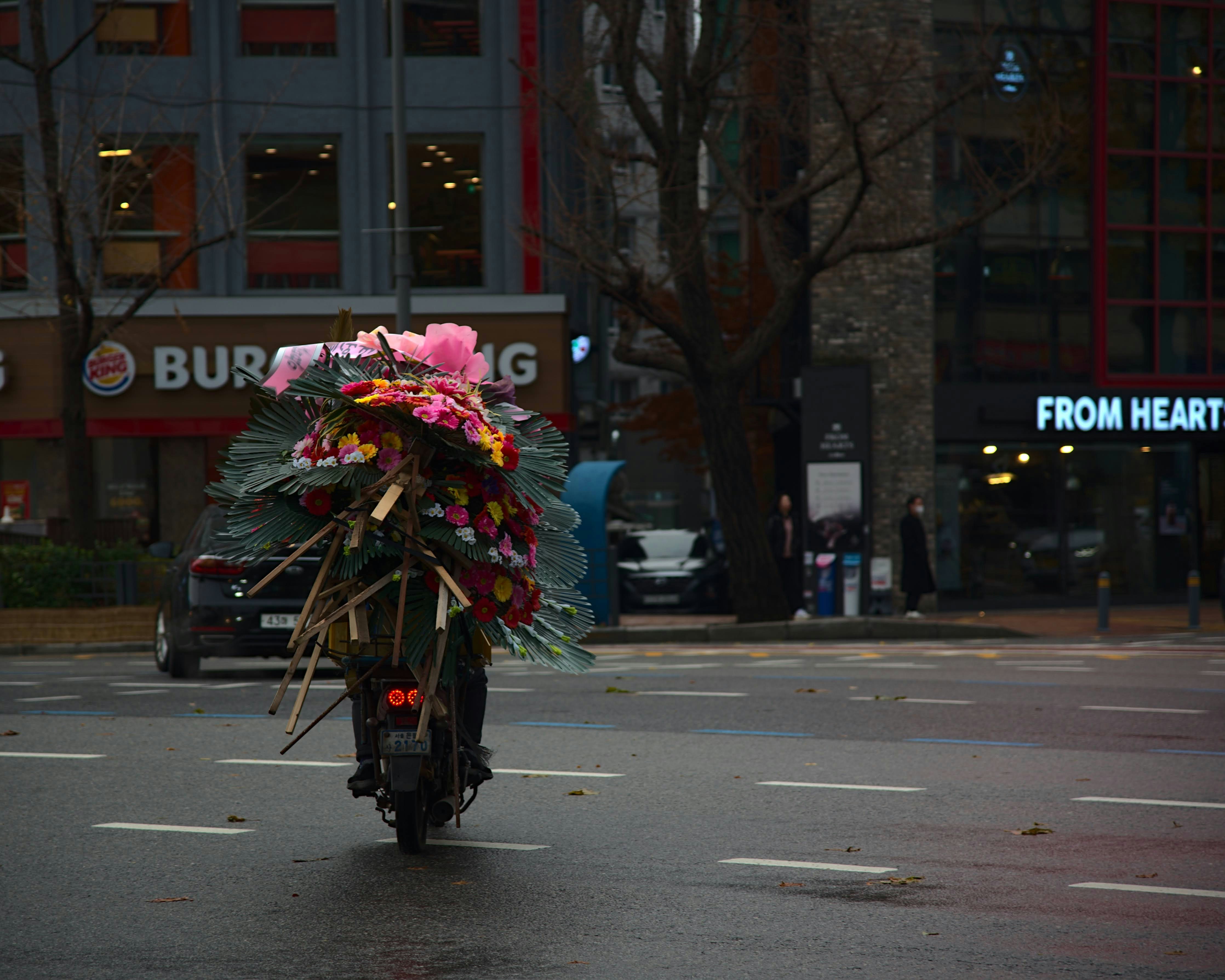 A motorcycle with a bunch of flowers on the back of it photo – Free ...