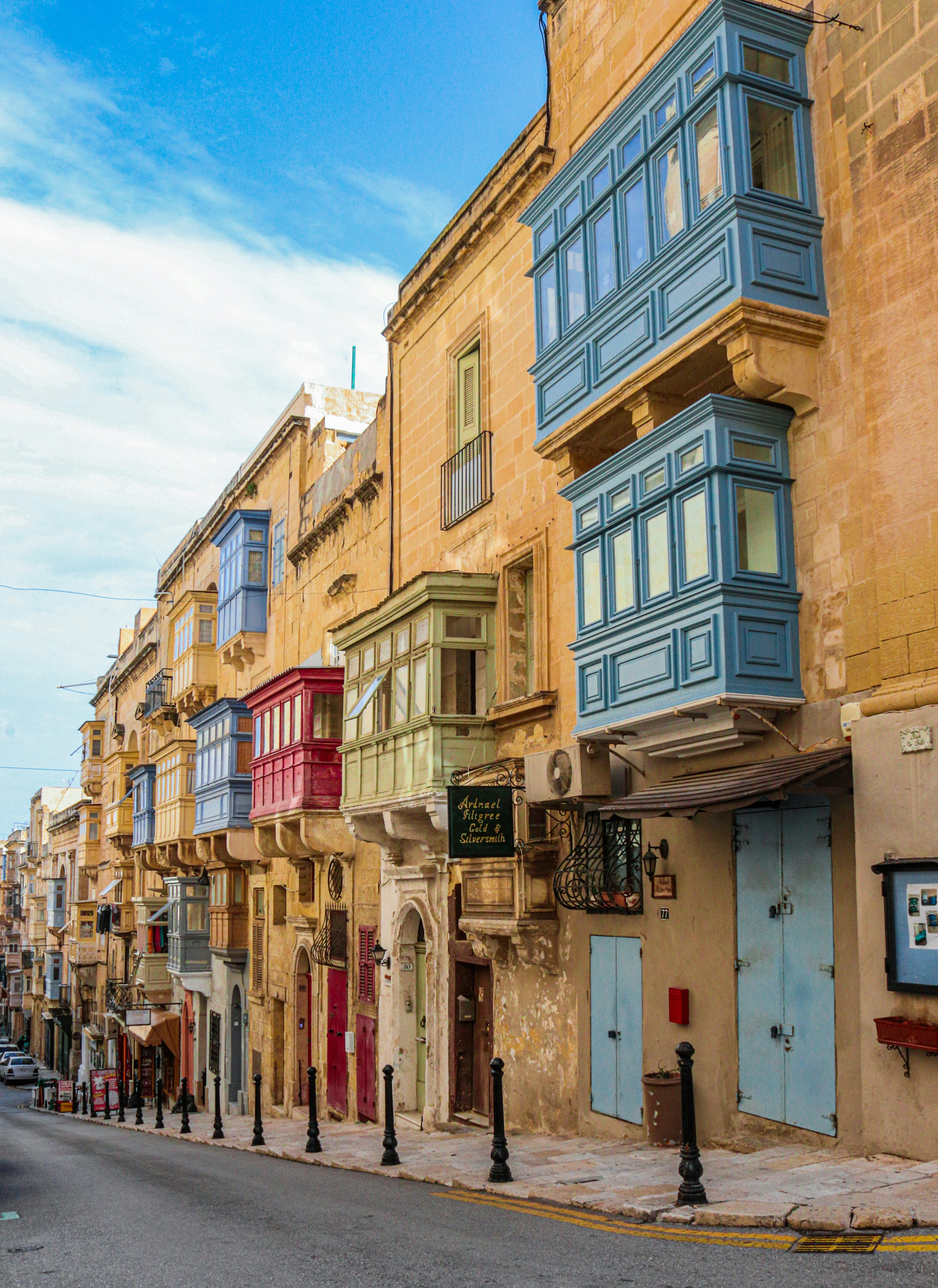 A row of buildings on the side of a street photo – Free Malta city ...
