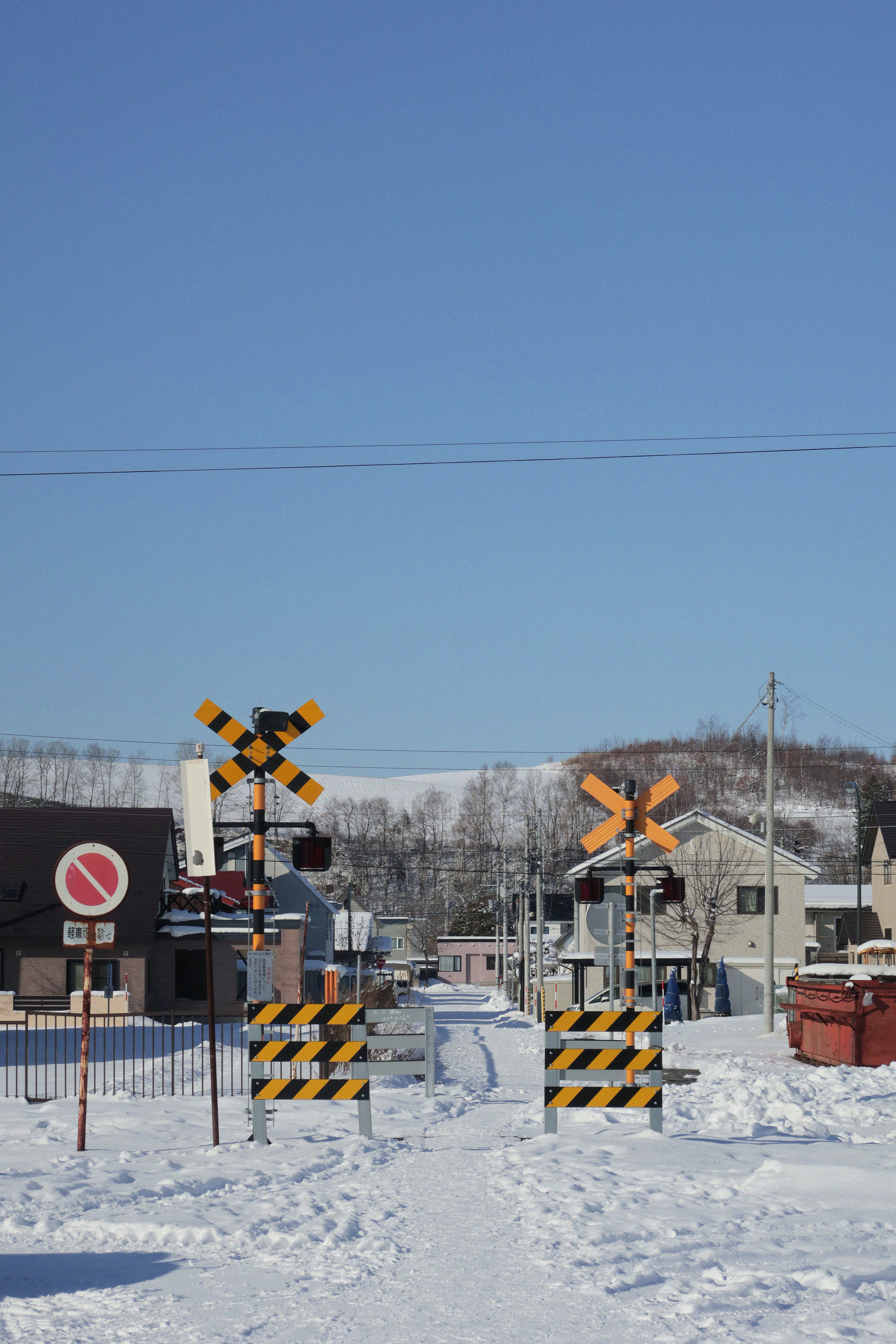 A snow covered field with a railroad crossing sign photo – Free Winter ...