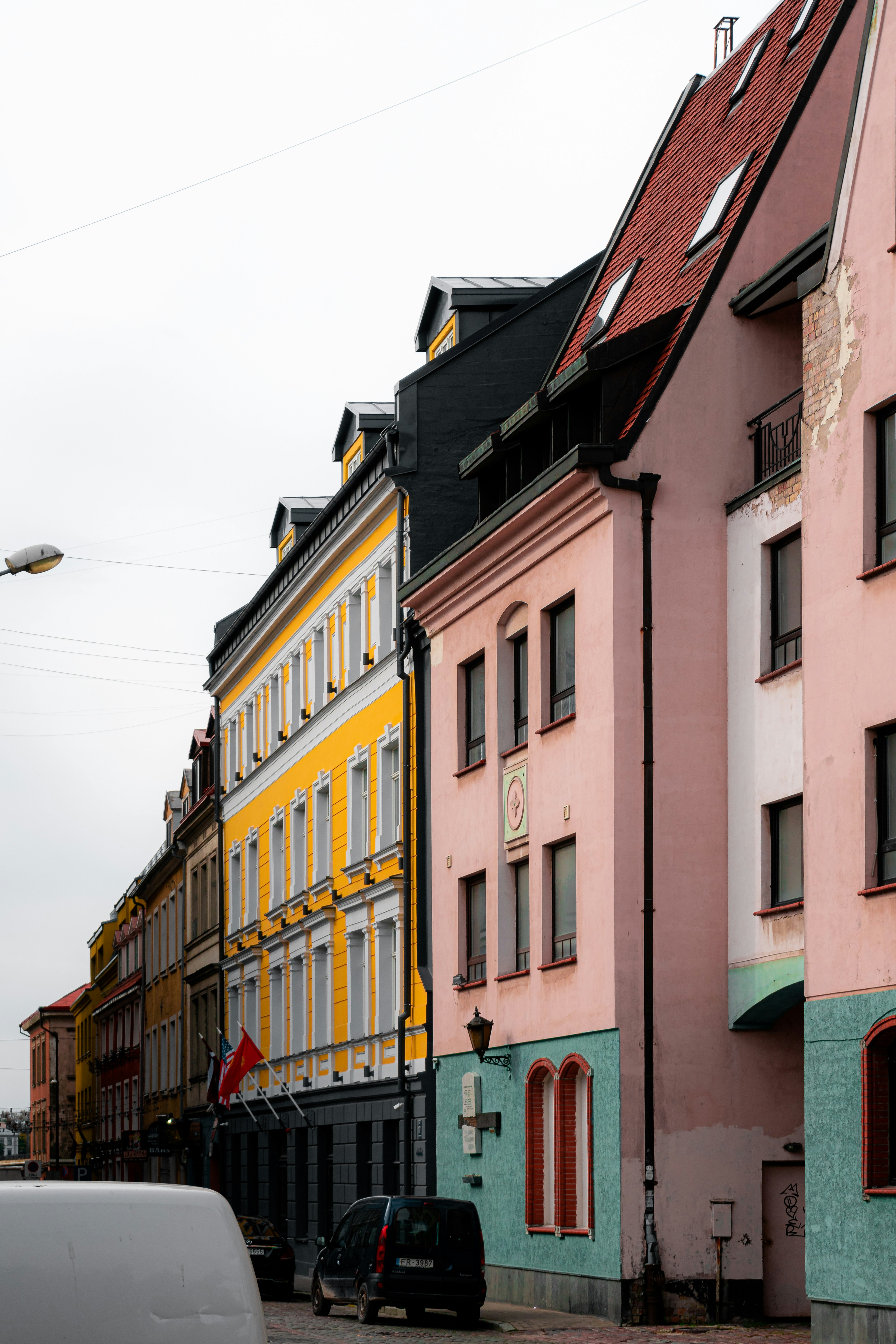 A row of colorful buildings on a city street photo – Free Riga Image on ...
