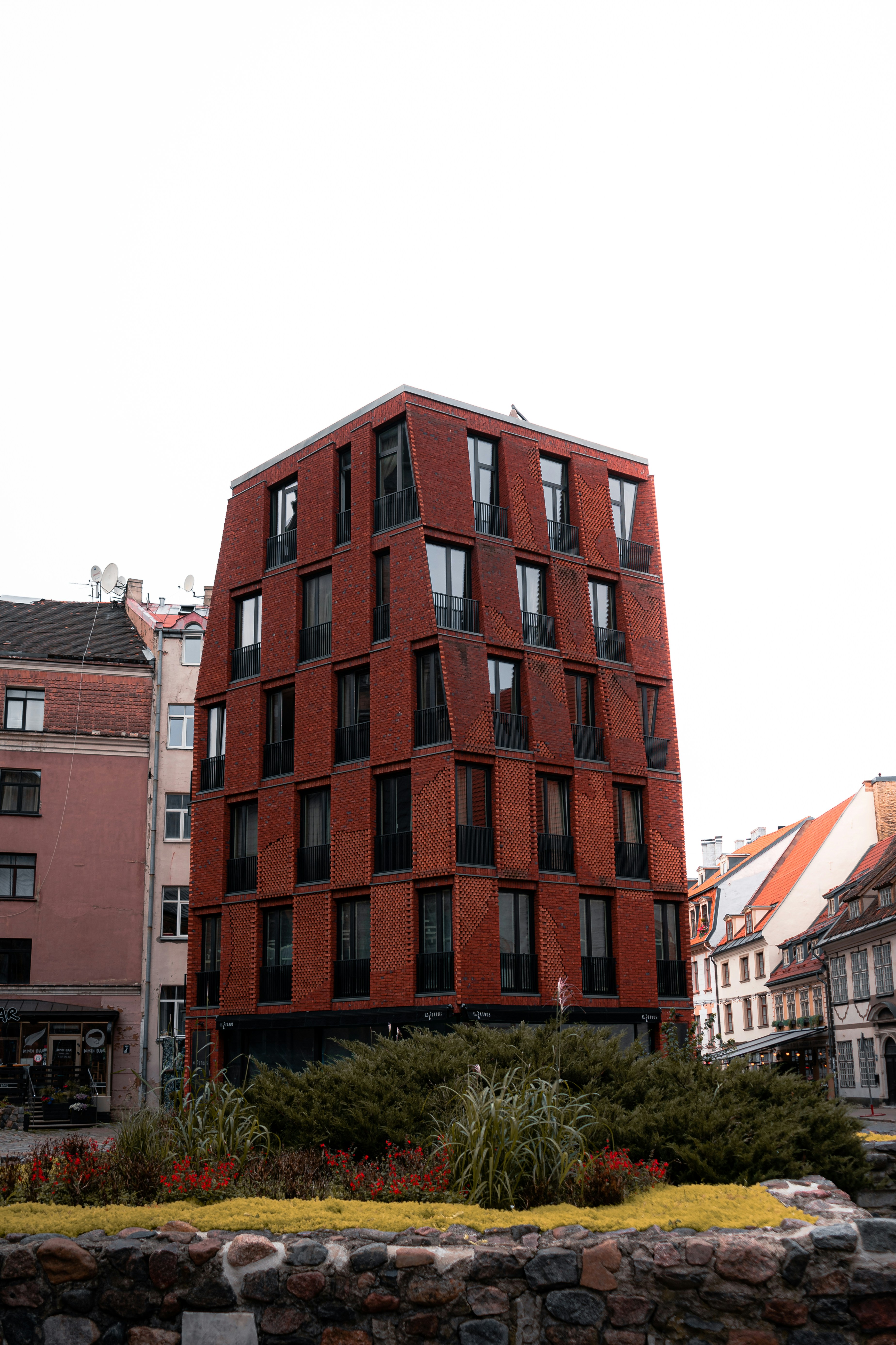 Brick Edifice Rising Over a Garden Barrier