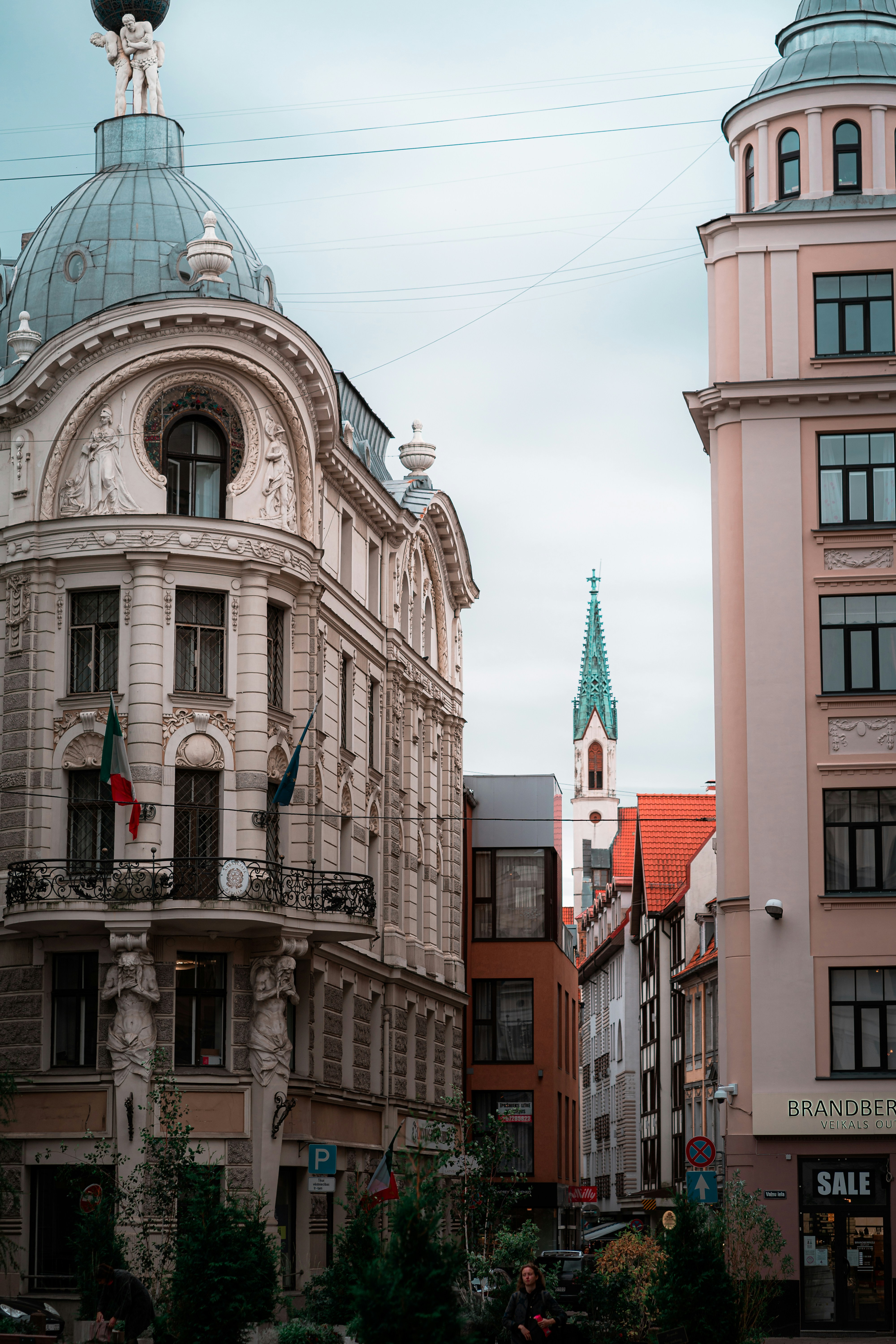 A city street lined with tall buildings and a clock tower photo – Free ...