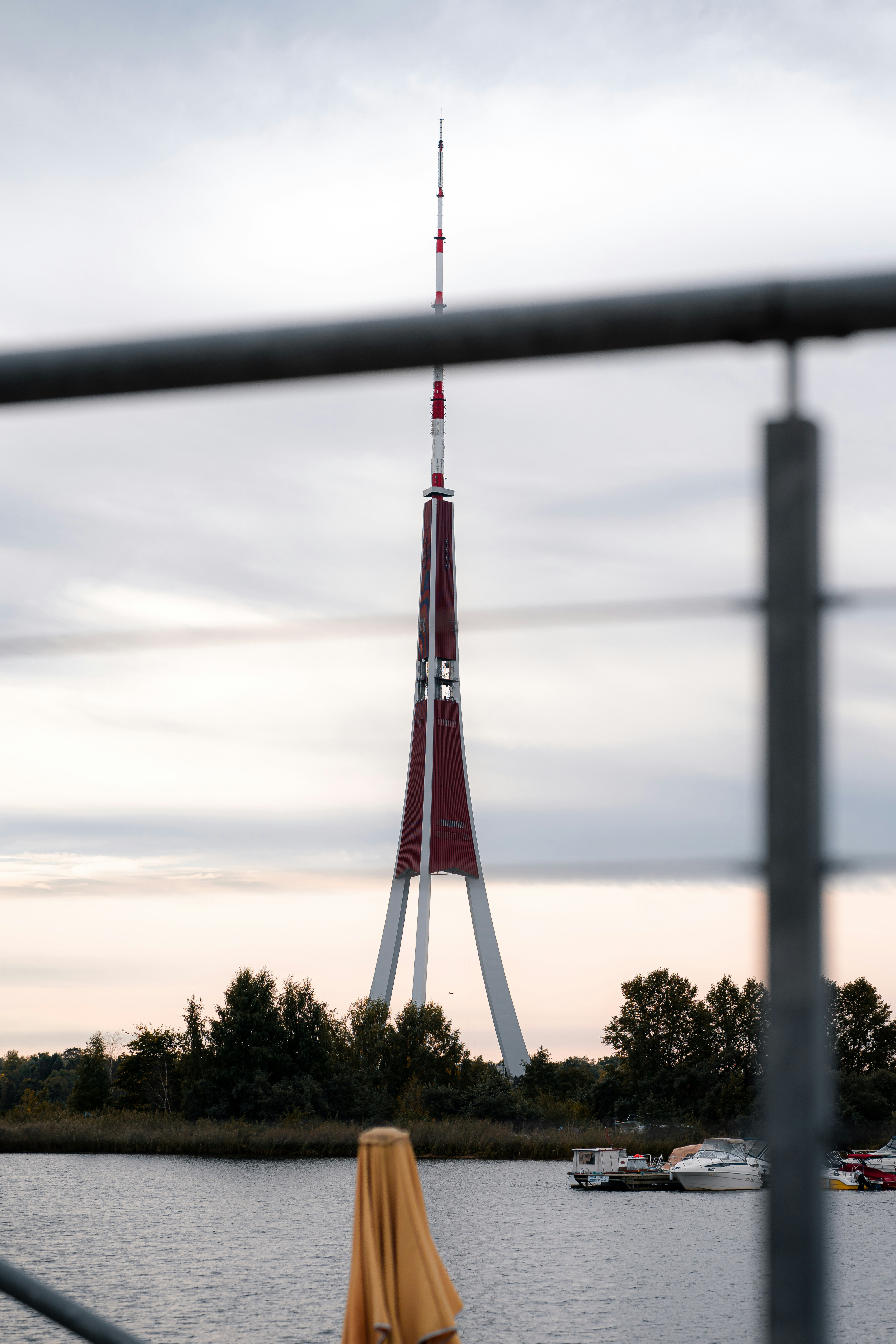 Tripod-Red Communications Tower Rising Over a Dusky Marsh