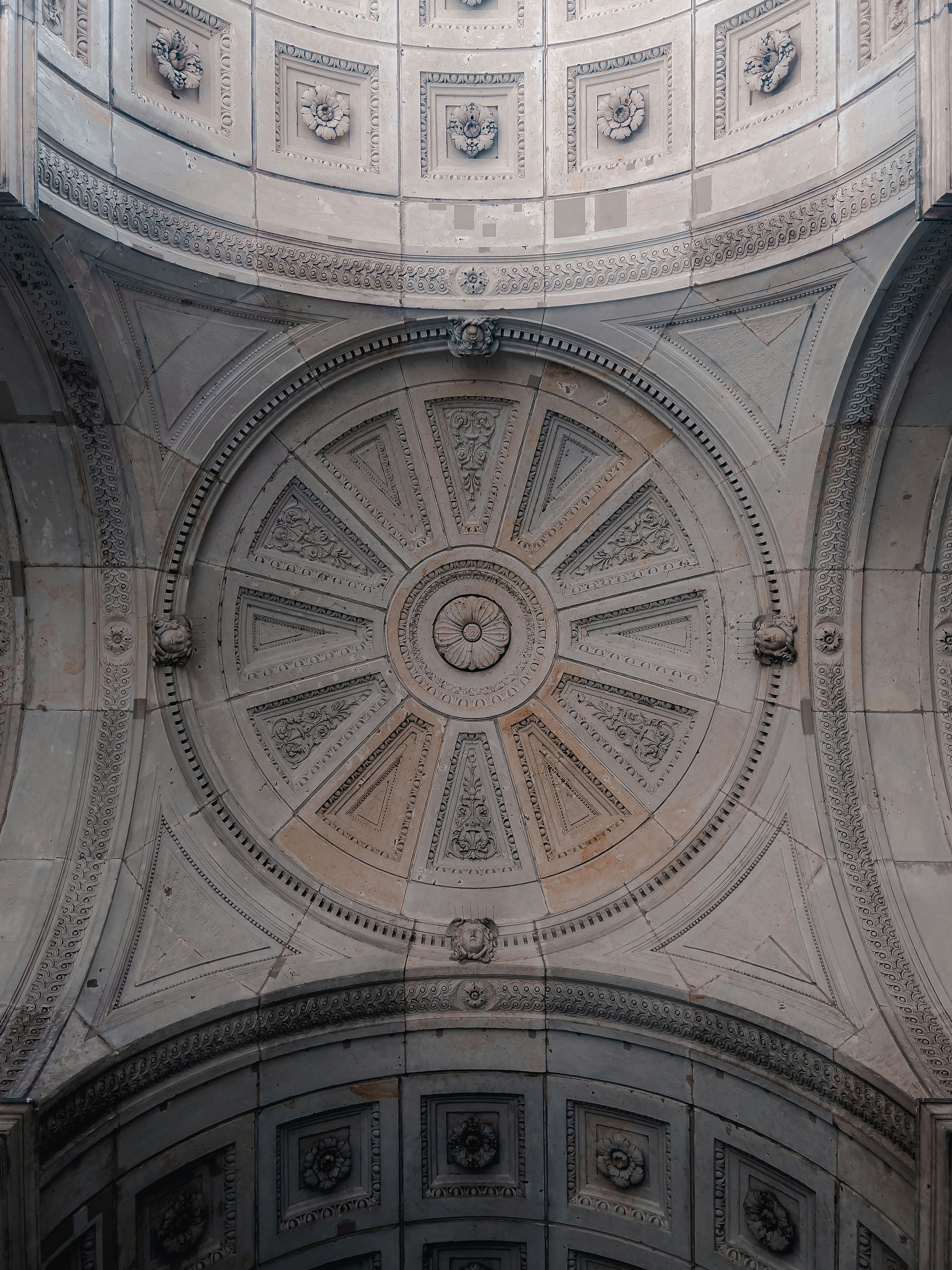 the ceiling of a building with a circular window