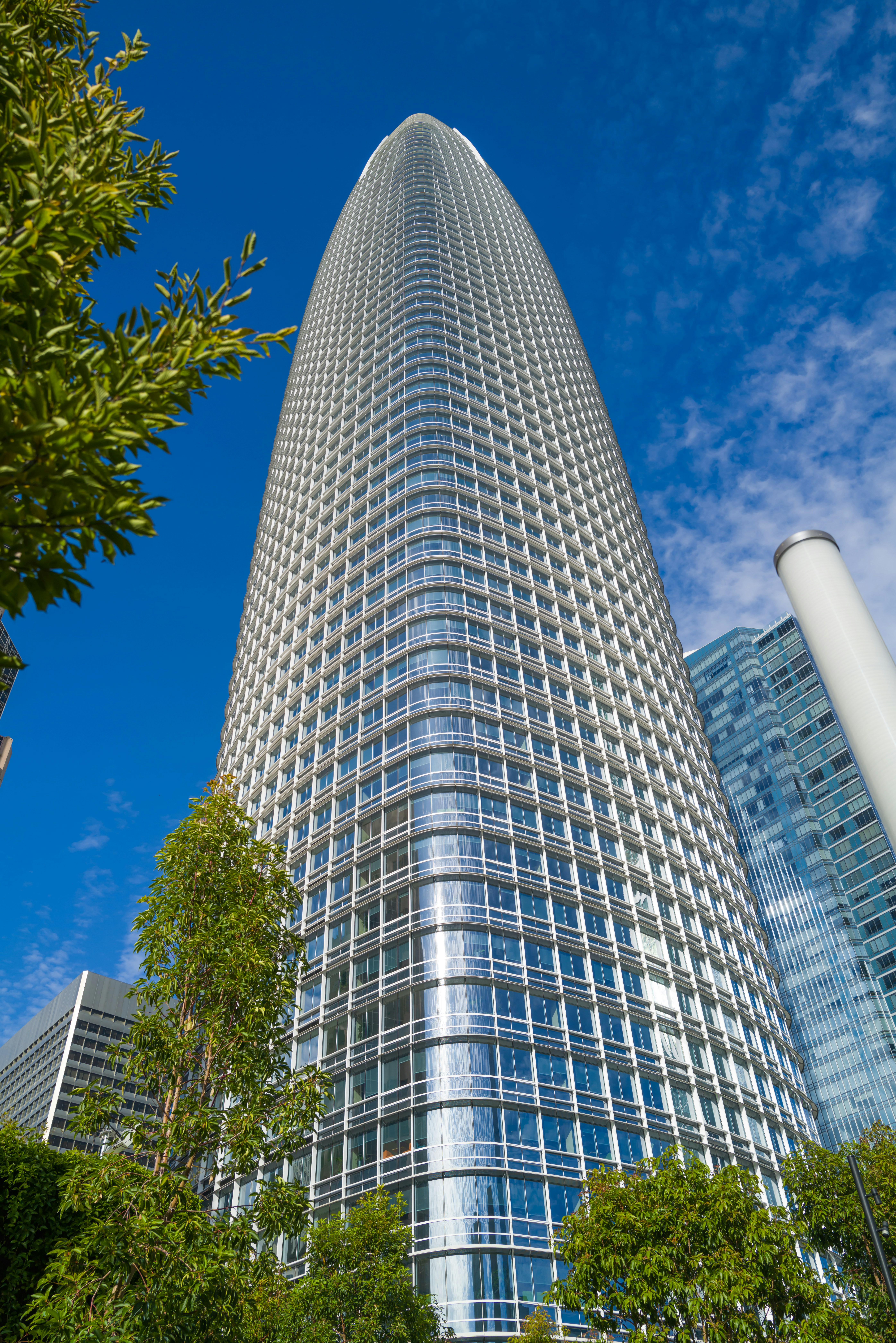 Glass Spine Ascends: A Curved Tower Piercing the Clear Sky