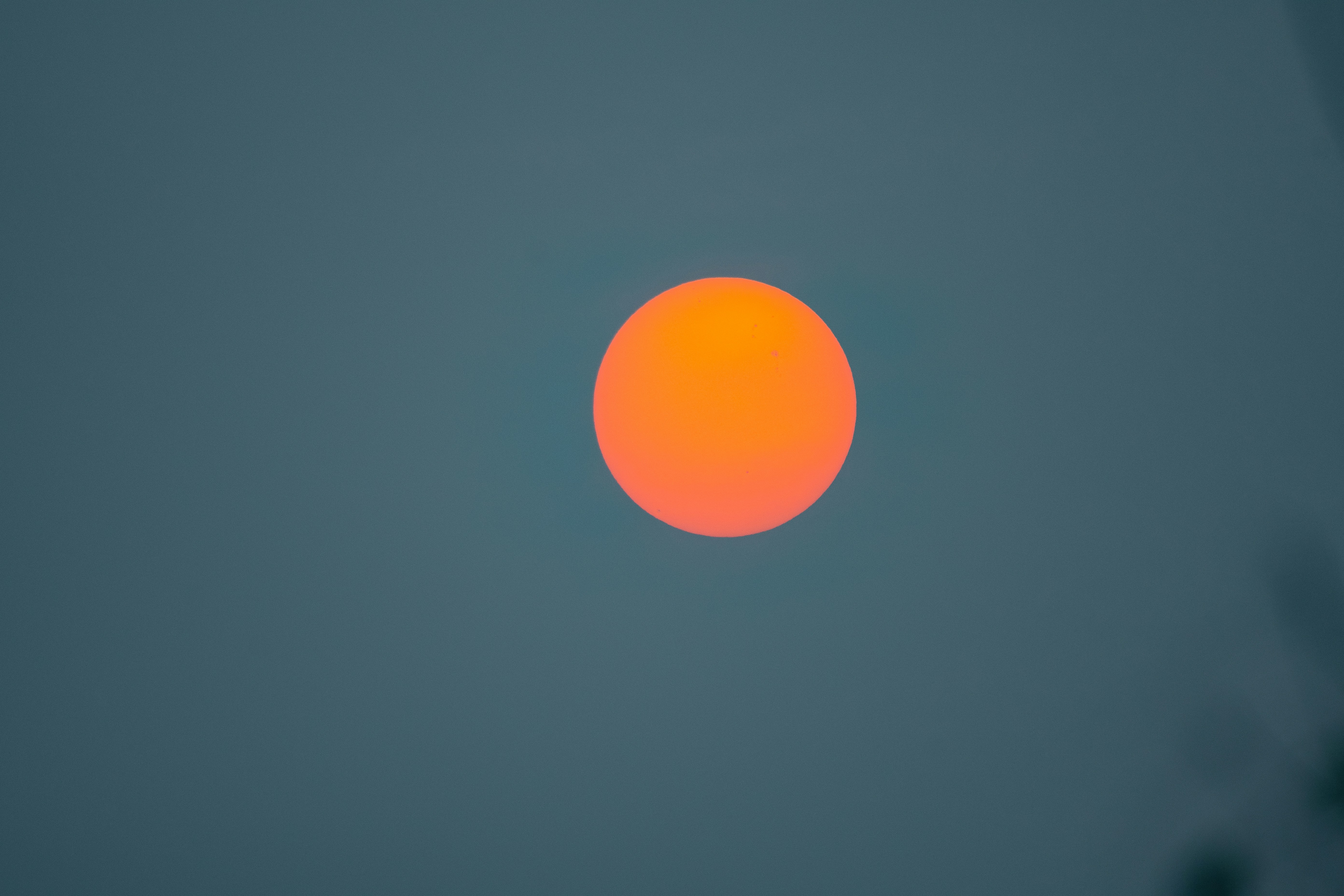 the sun is setting in the dark sky