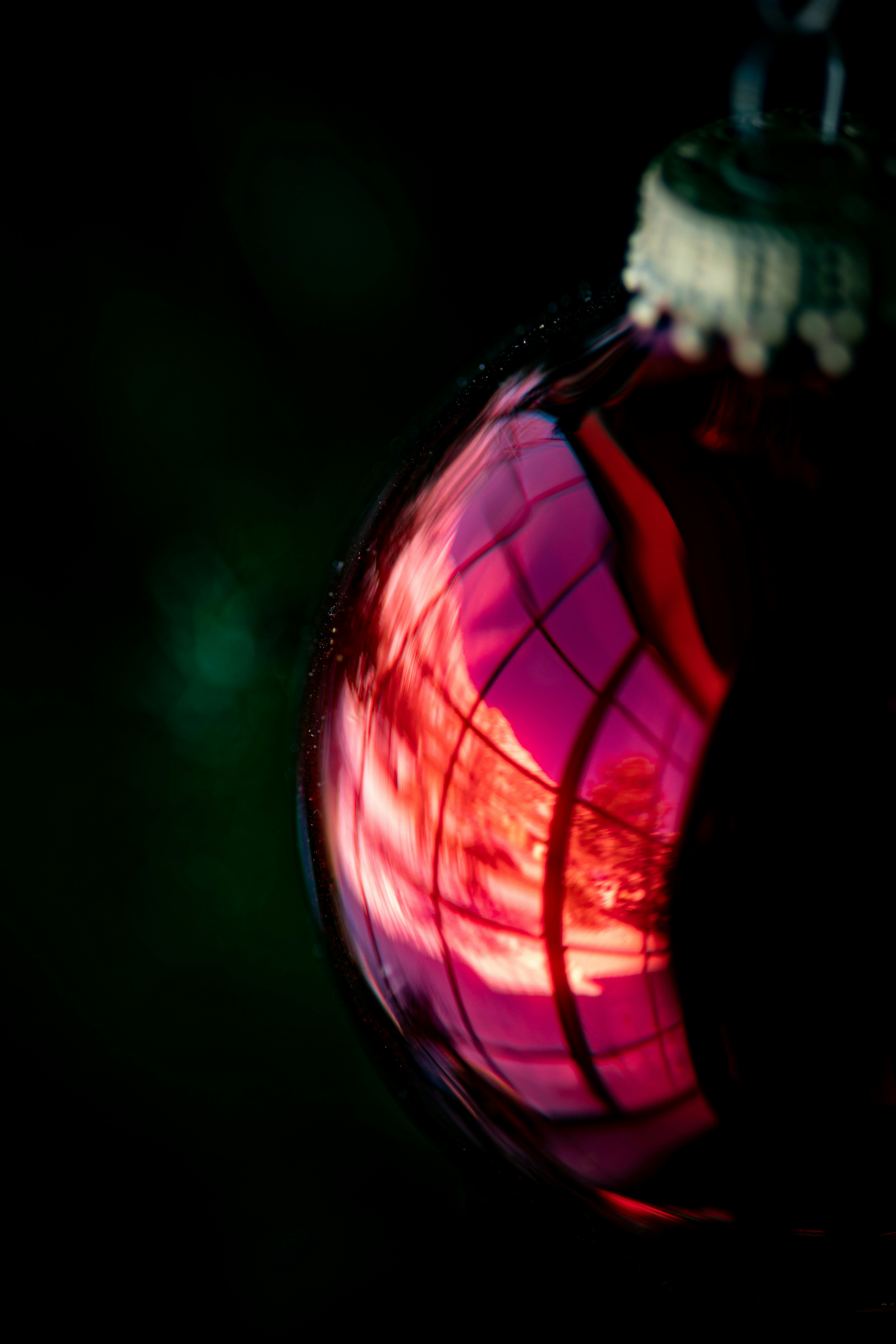 Crimson Reflection: A Glass Ornament in Velvet Darkness