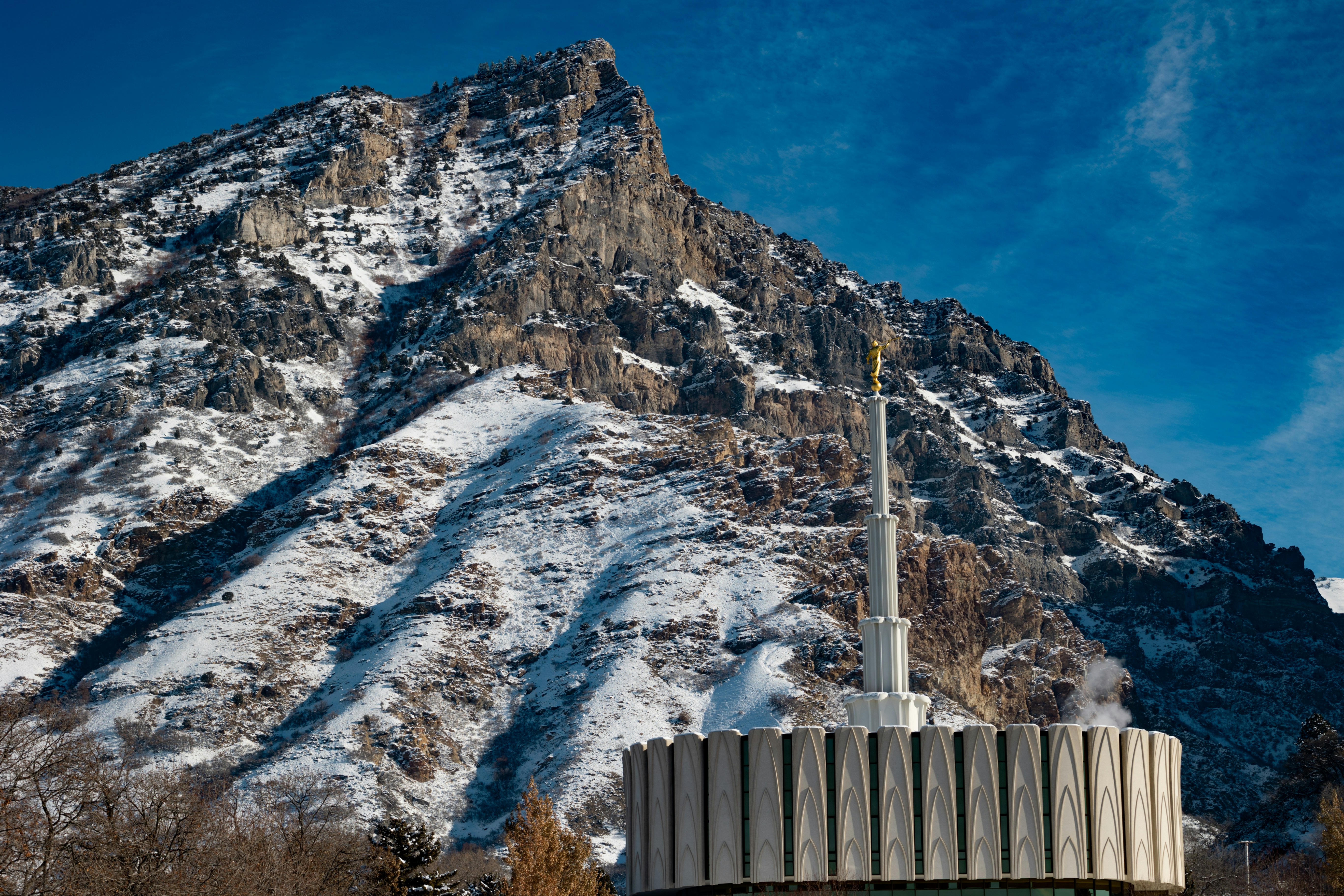 A tall mountain with a tower in the middle of it photo – Free Mountain ...