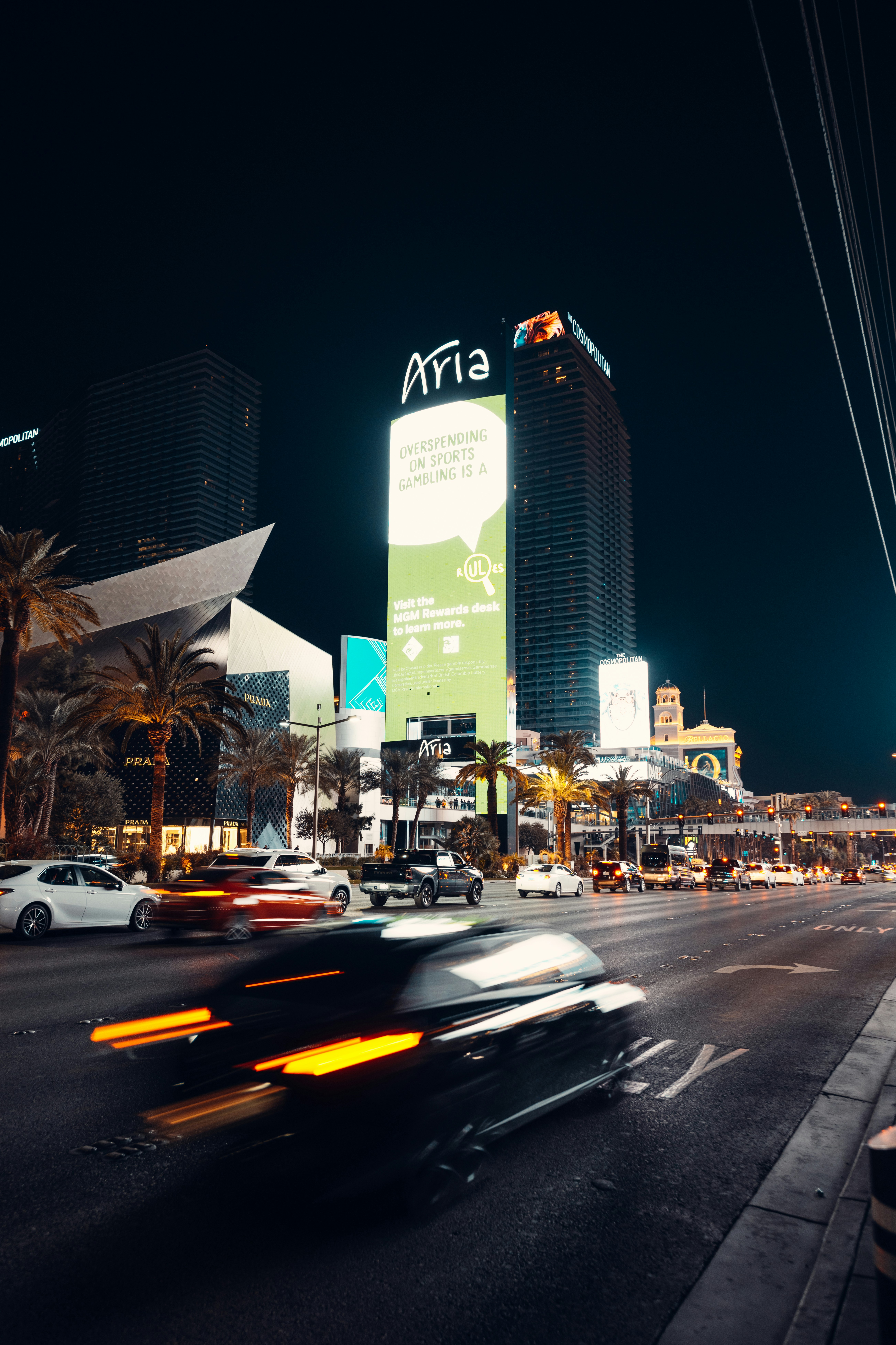 Aria Tower at Midnight: Neon Signage and Street Motion on Las Vegas Boulevard