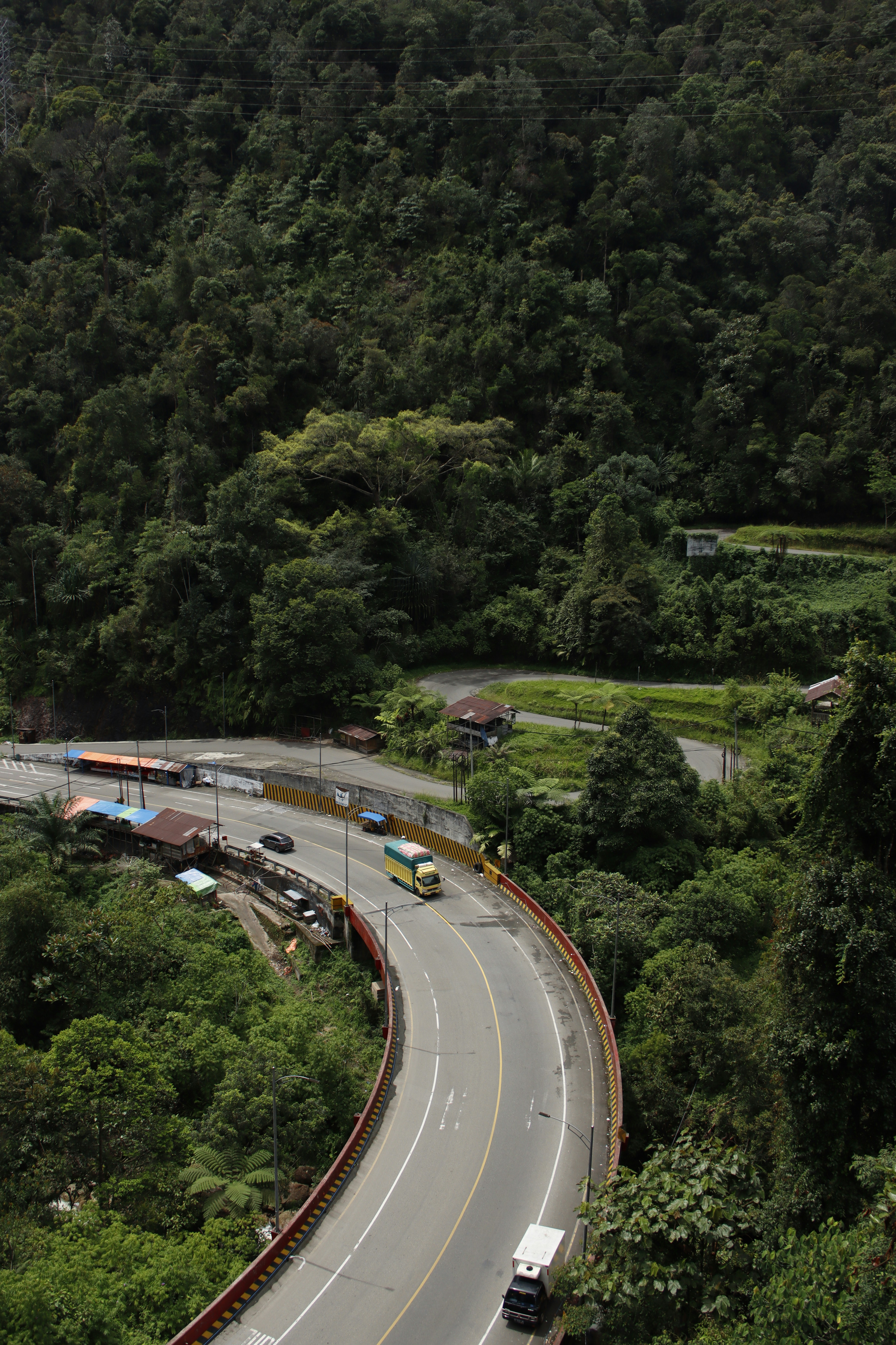 A long curved road with a bus on it photo – Free Nature background ...
