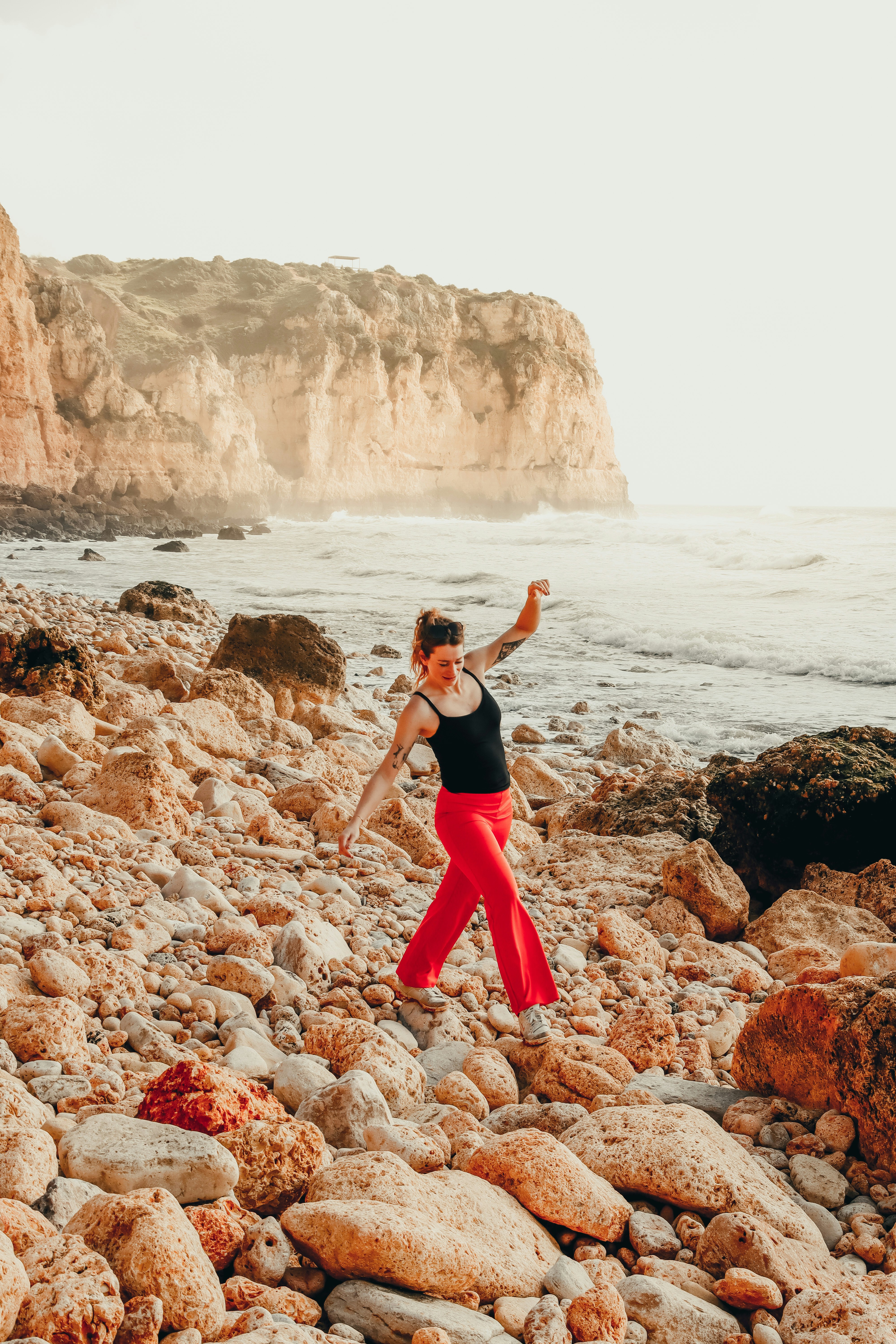 Pebble-stage Serenade: A Solo Dancer by the Cliffside Shore