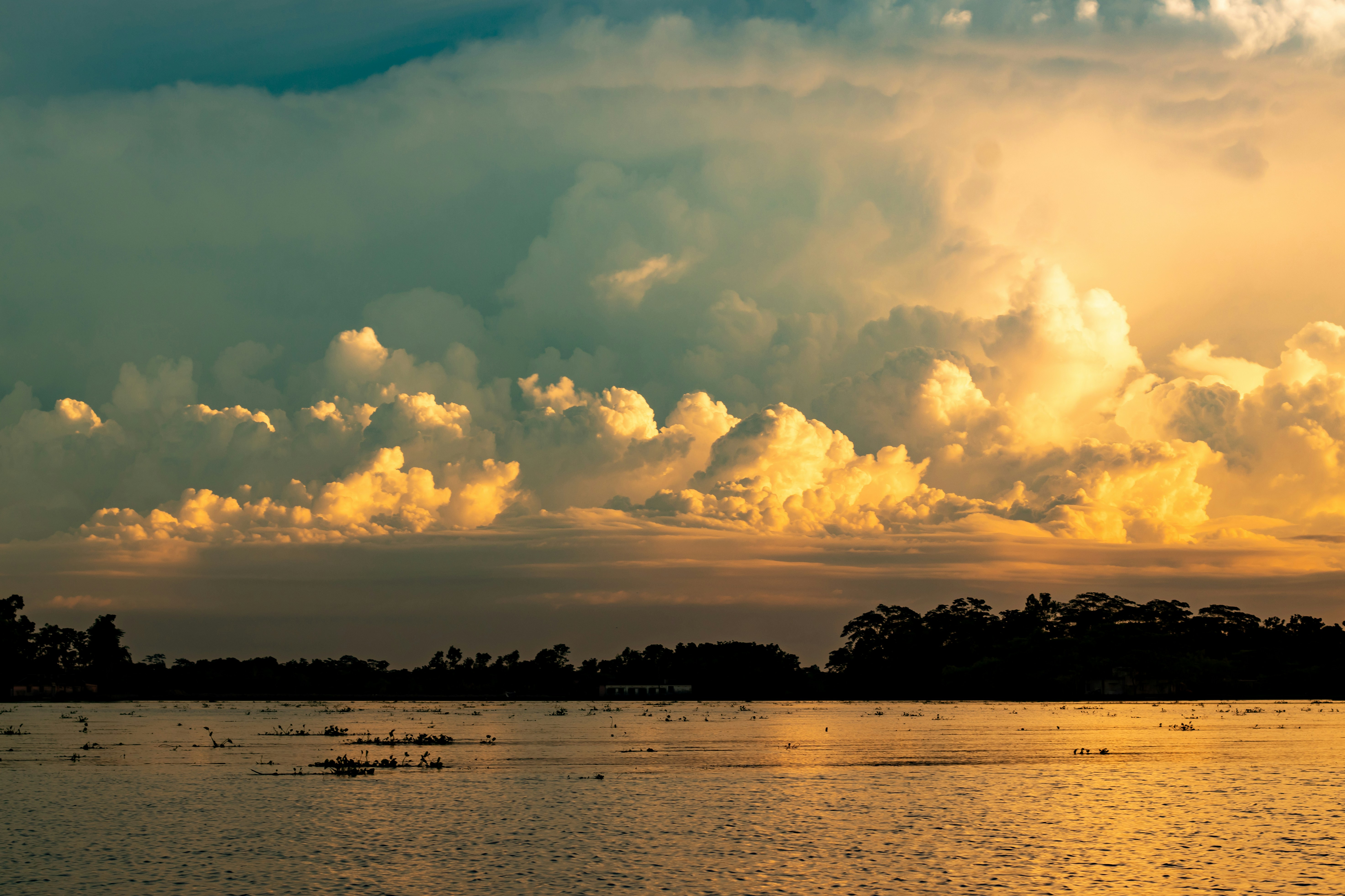 The sky is on fire | a large body of water under a cloudy sky
