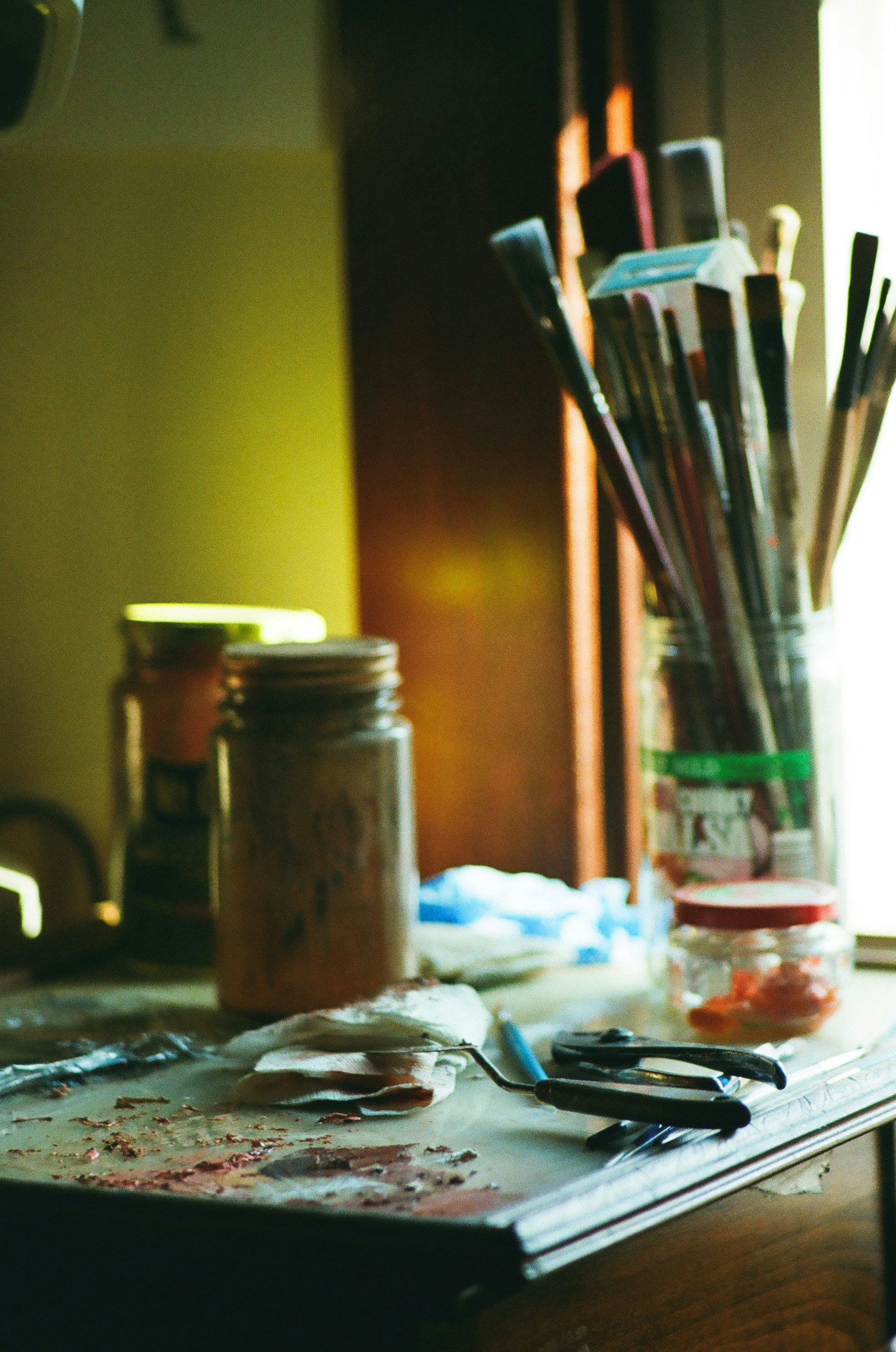 A wooden table topped with lots of art supplies photo – Free #studio ...