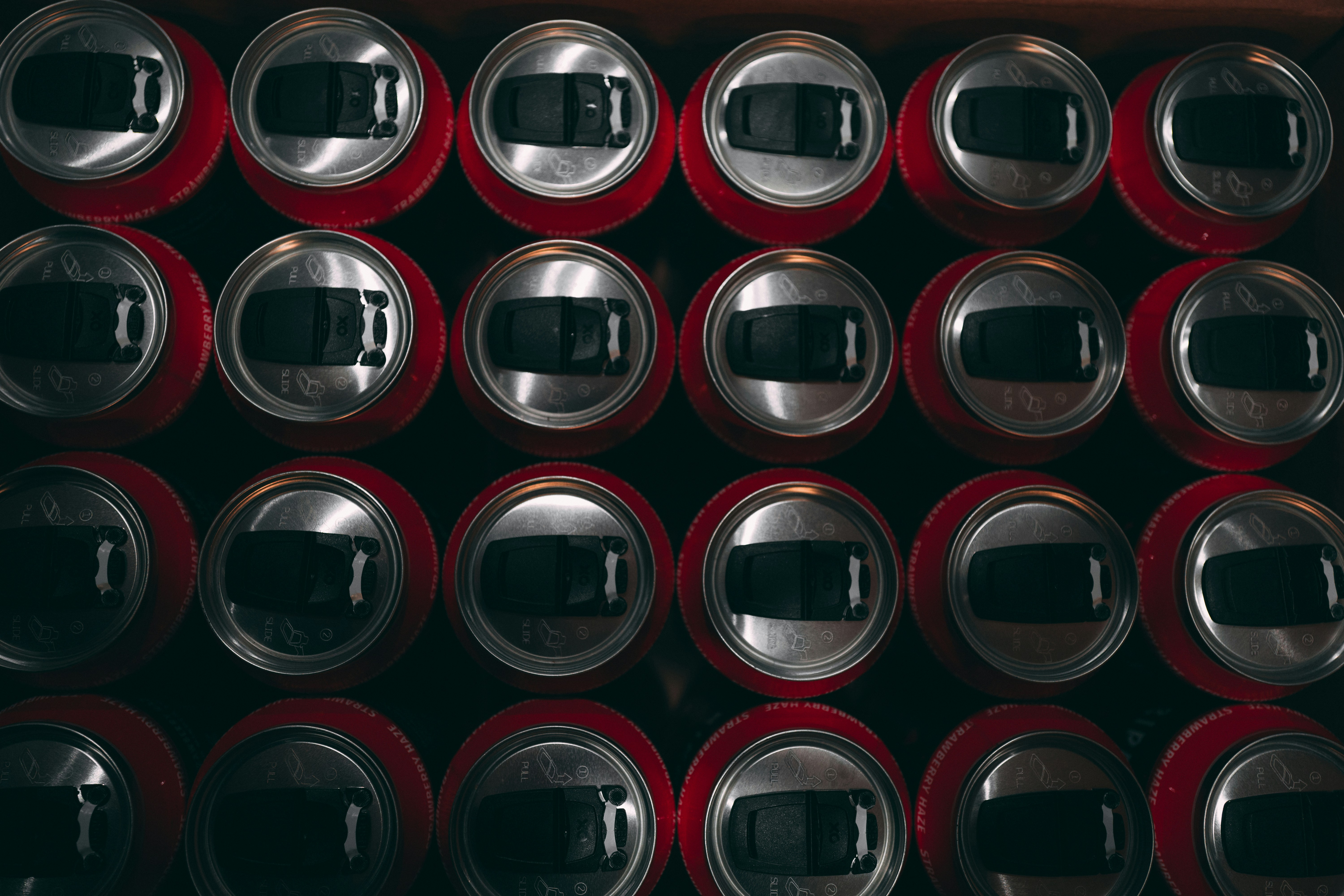 A bunch of soda cans stacked on top of each other photo – Free Beverage ...