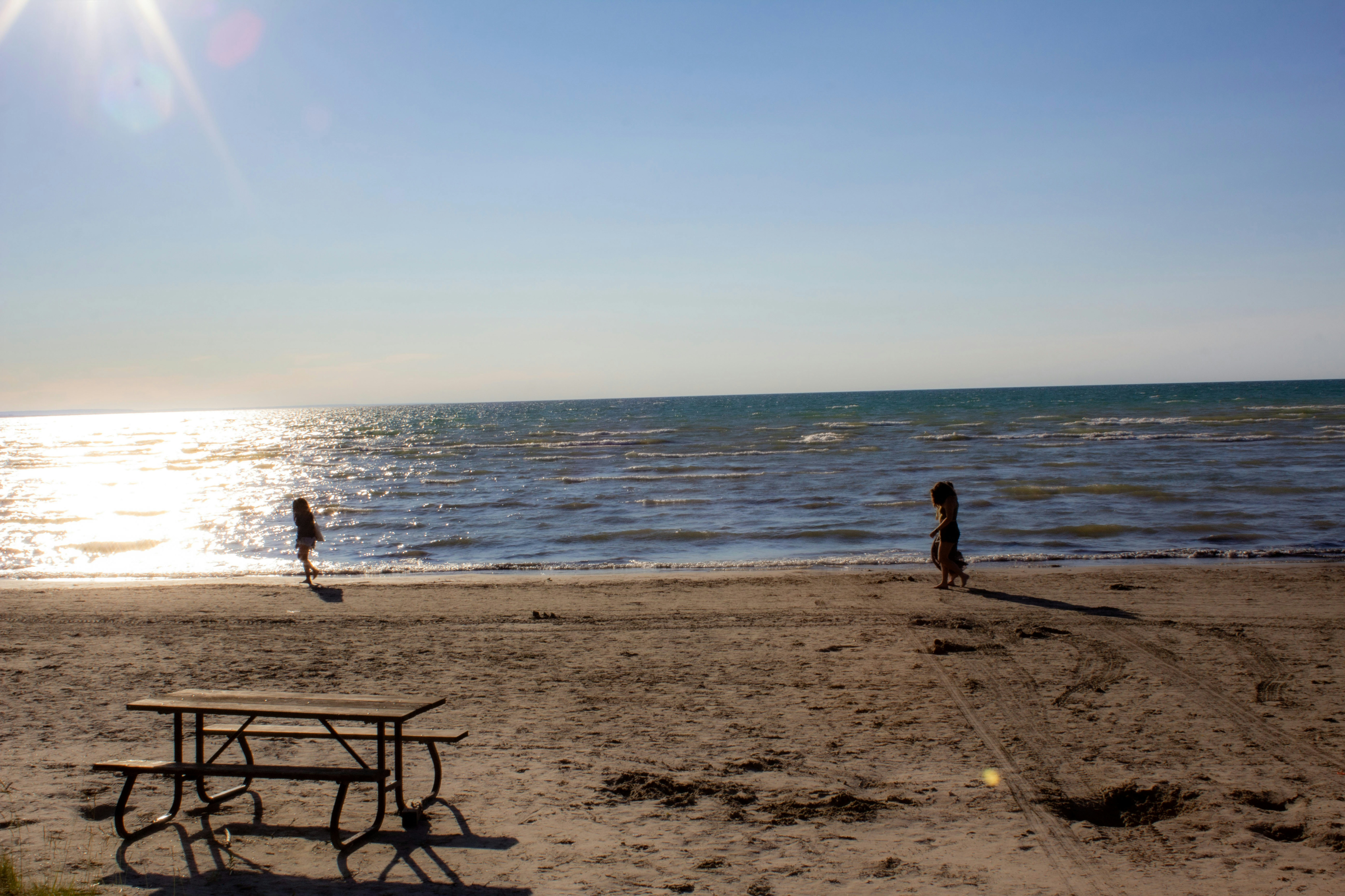 Sunlit Shoreline with Children at Play