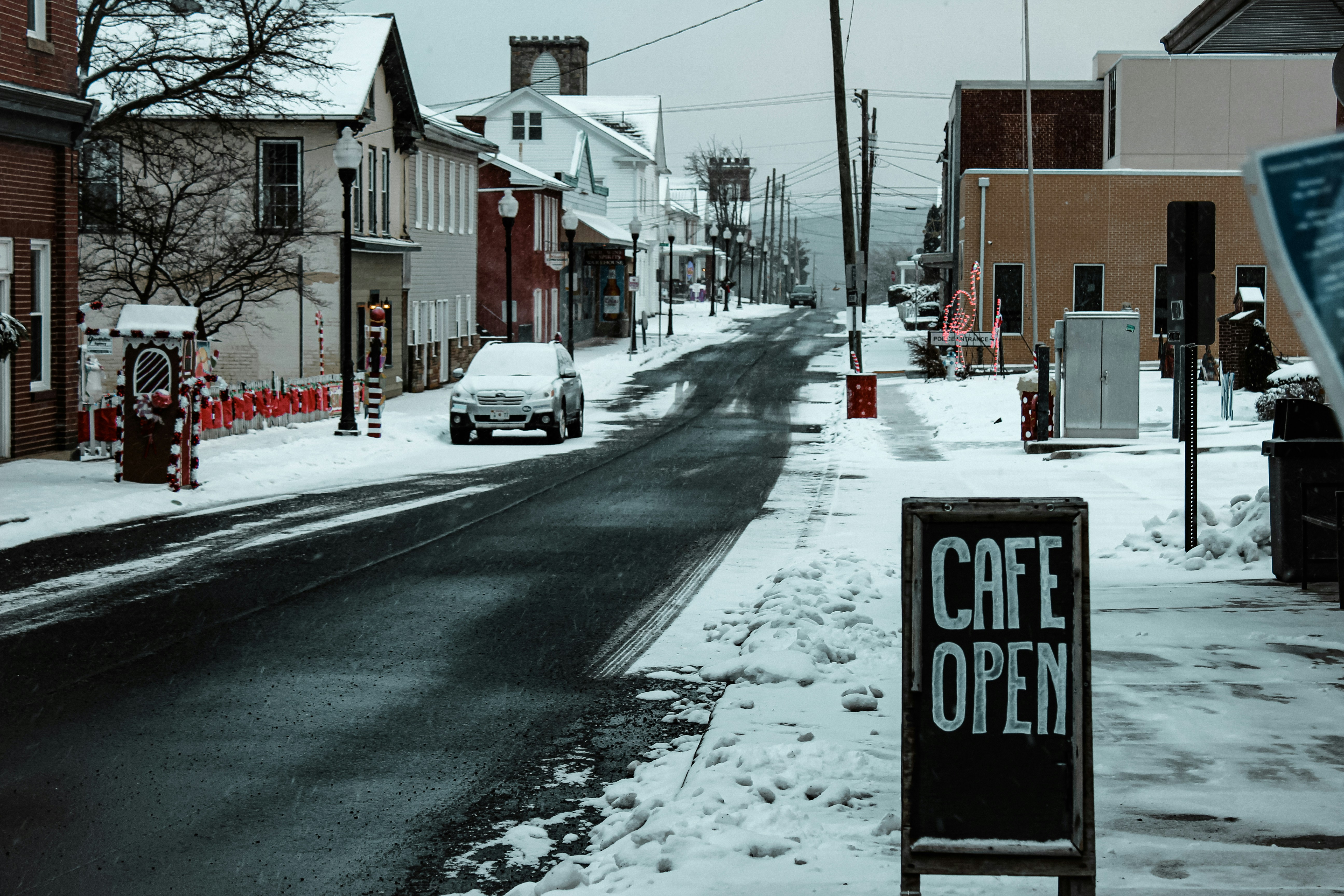 Street photo of Cumberland MD, cafe is open and the road is covered with snow