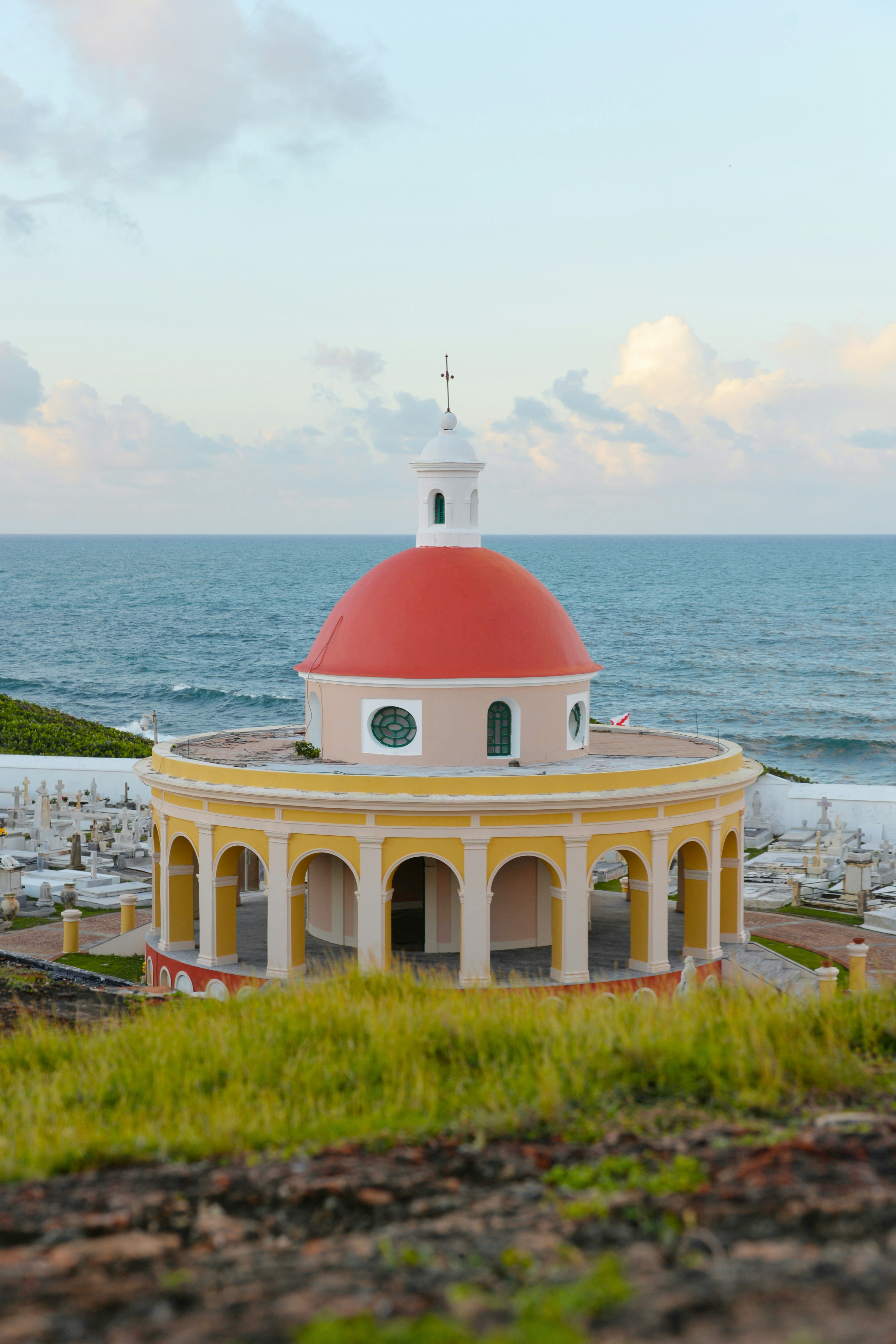 A white and red dome with a red roof near the ocean photo – Free Nature ...
