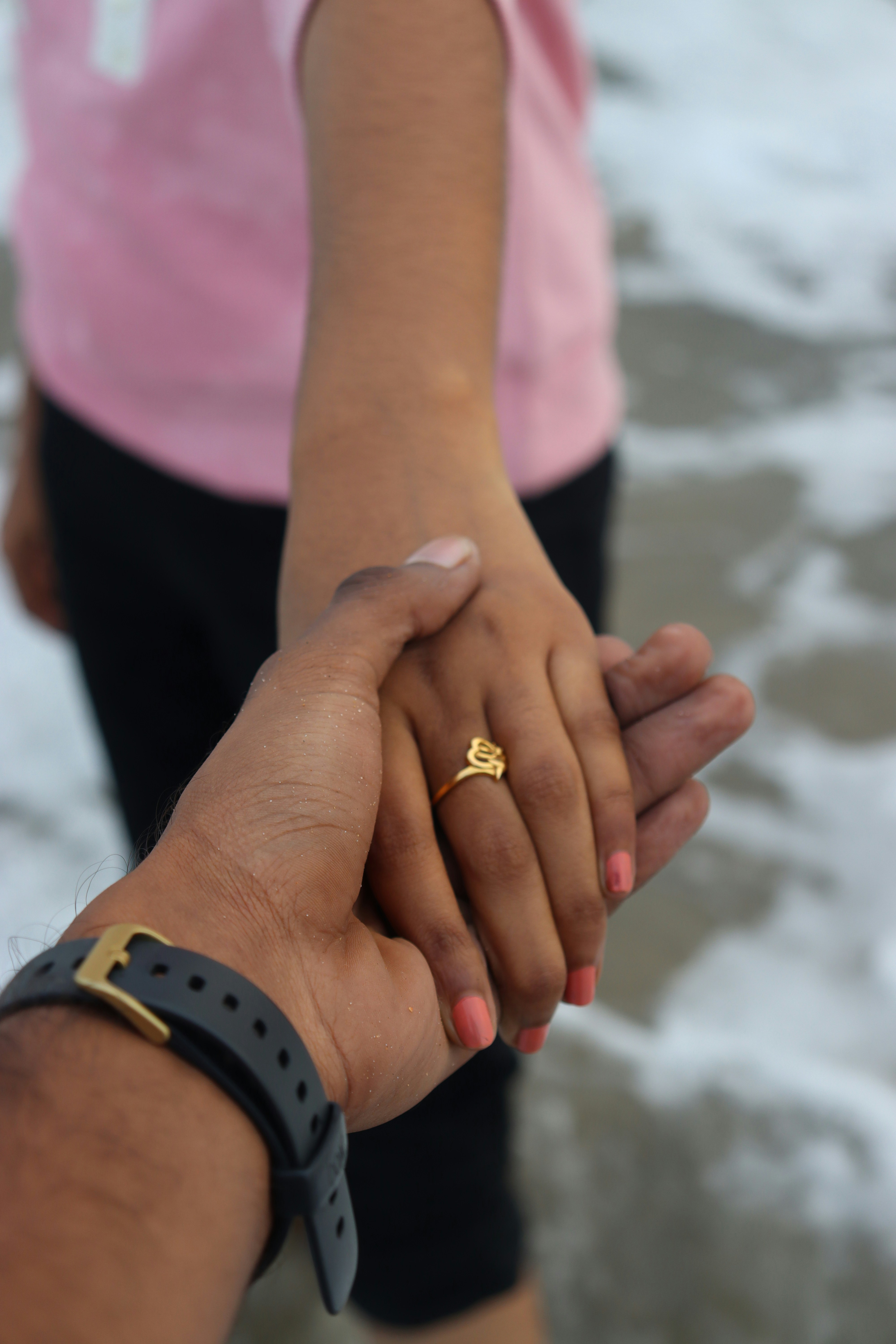 A Quiet Promise by the Shore: Hands Joined, Ring Catching the Light