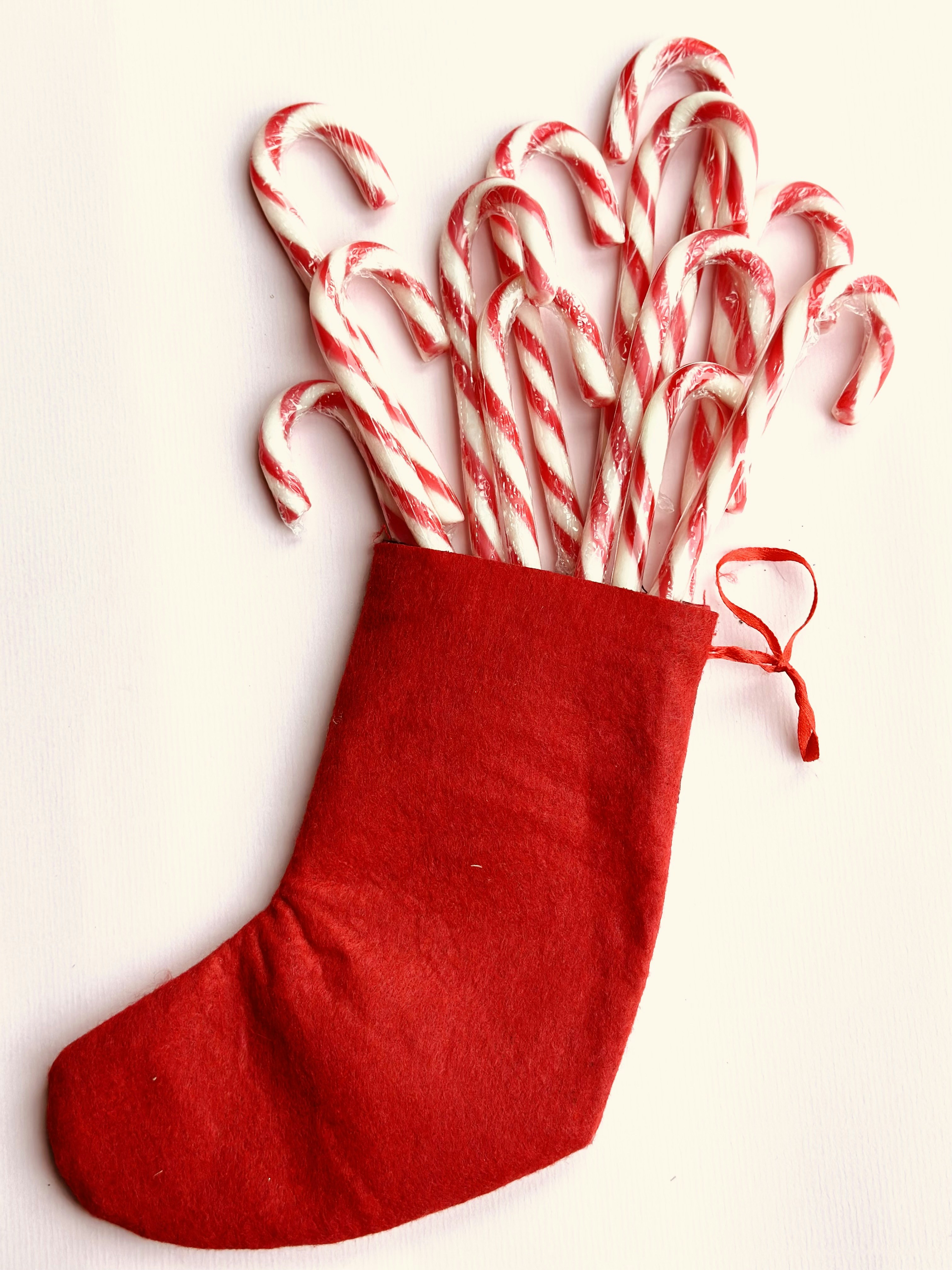 A stocking filled with candy canes sitting on top of a table photo ...