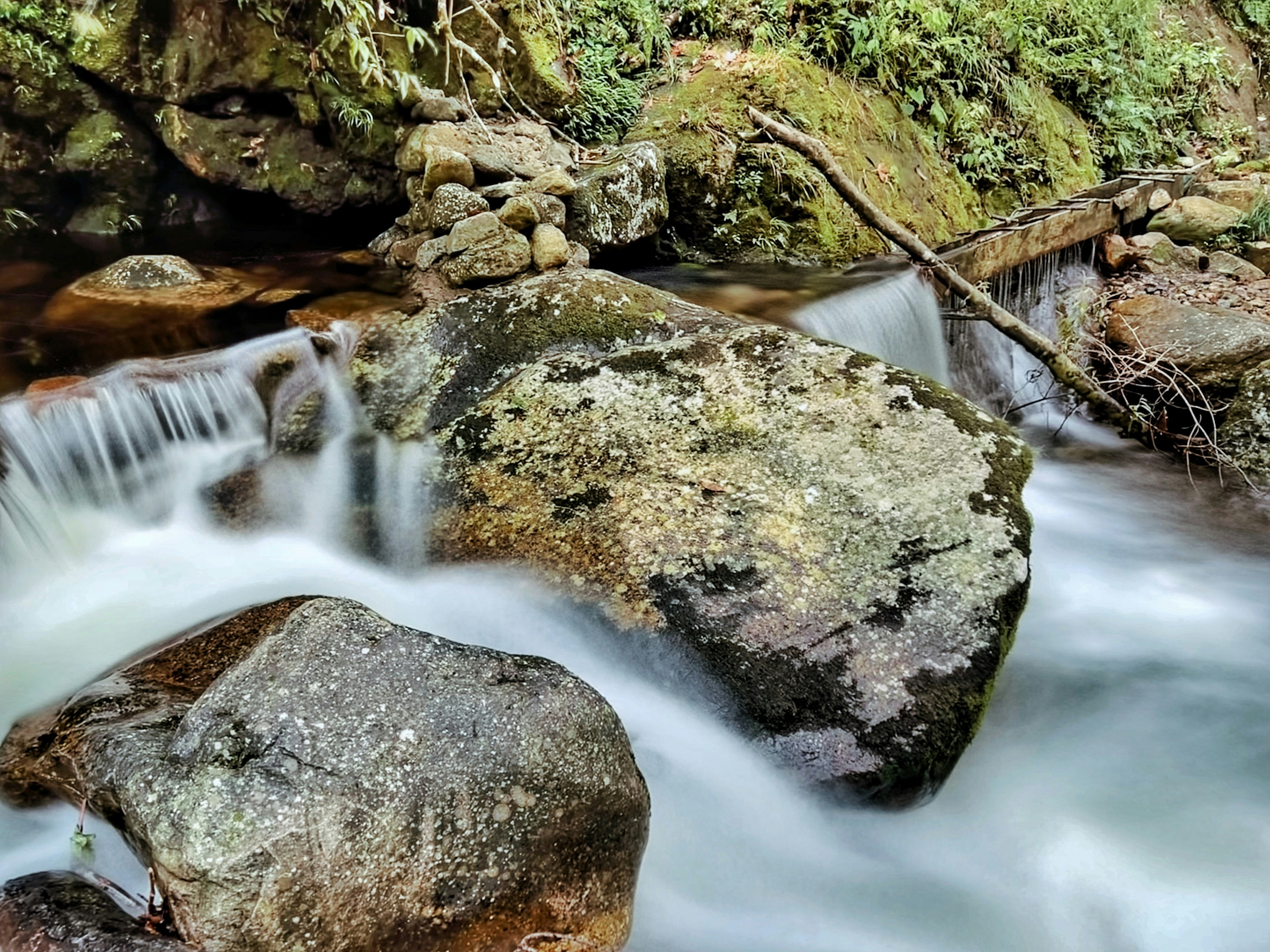 A stream of water running over rocks in a forest photo – Free Vietnam ...