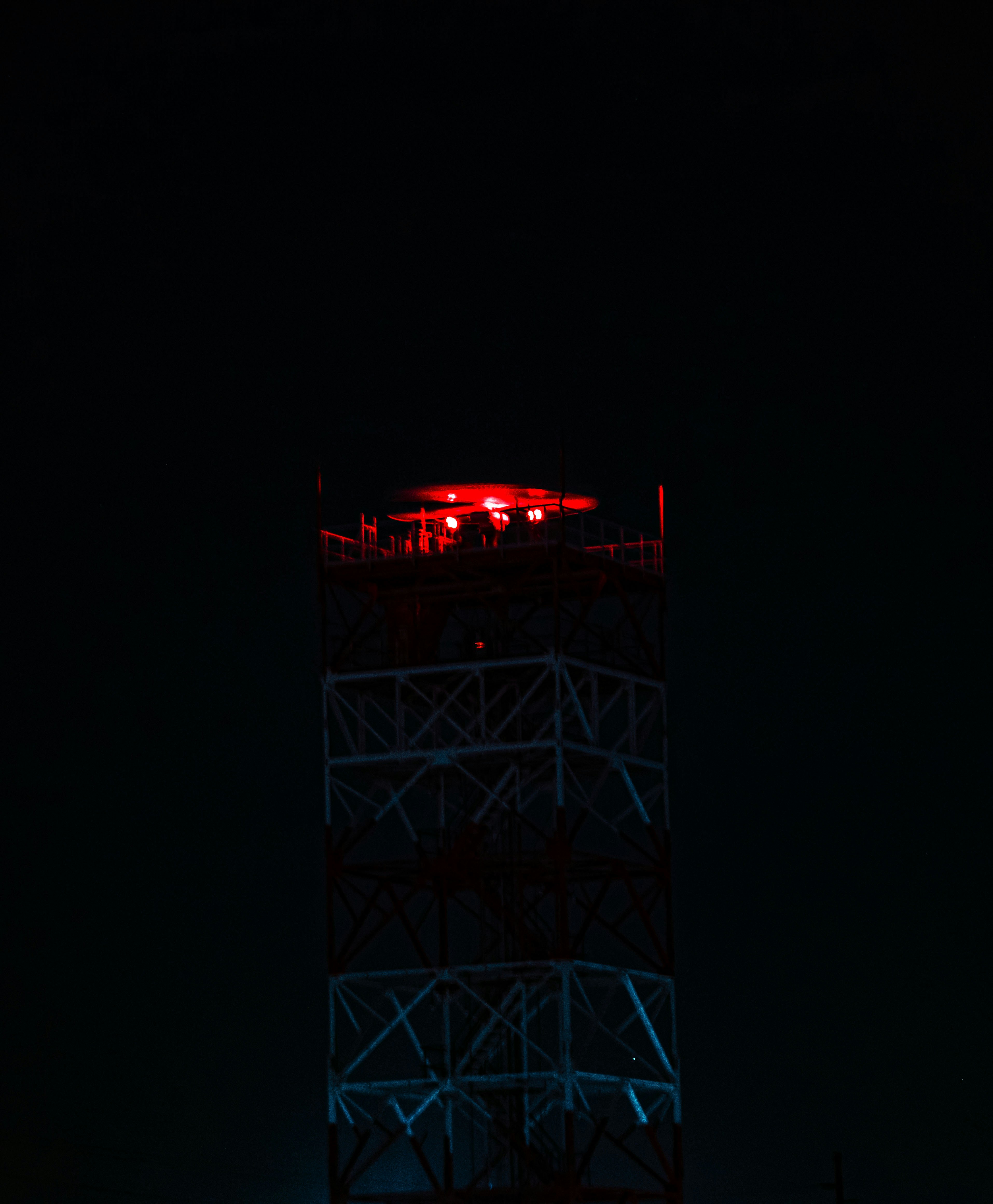 A tall tower with a red light on top of it photo – Free East sky harbor ...