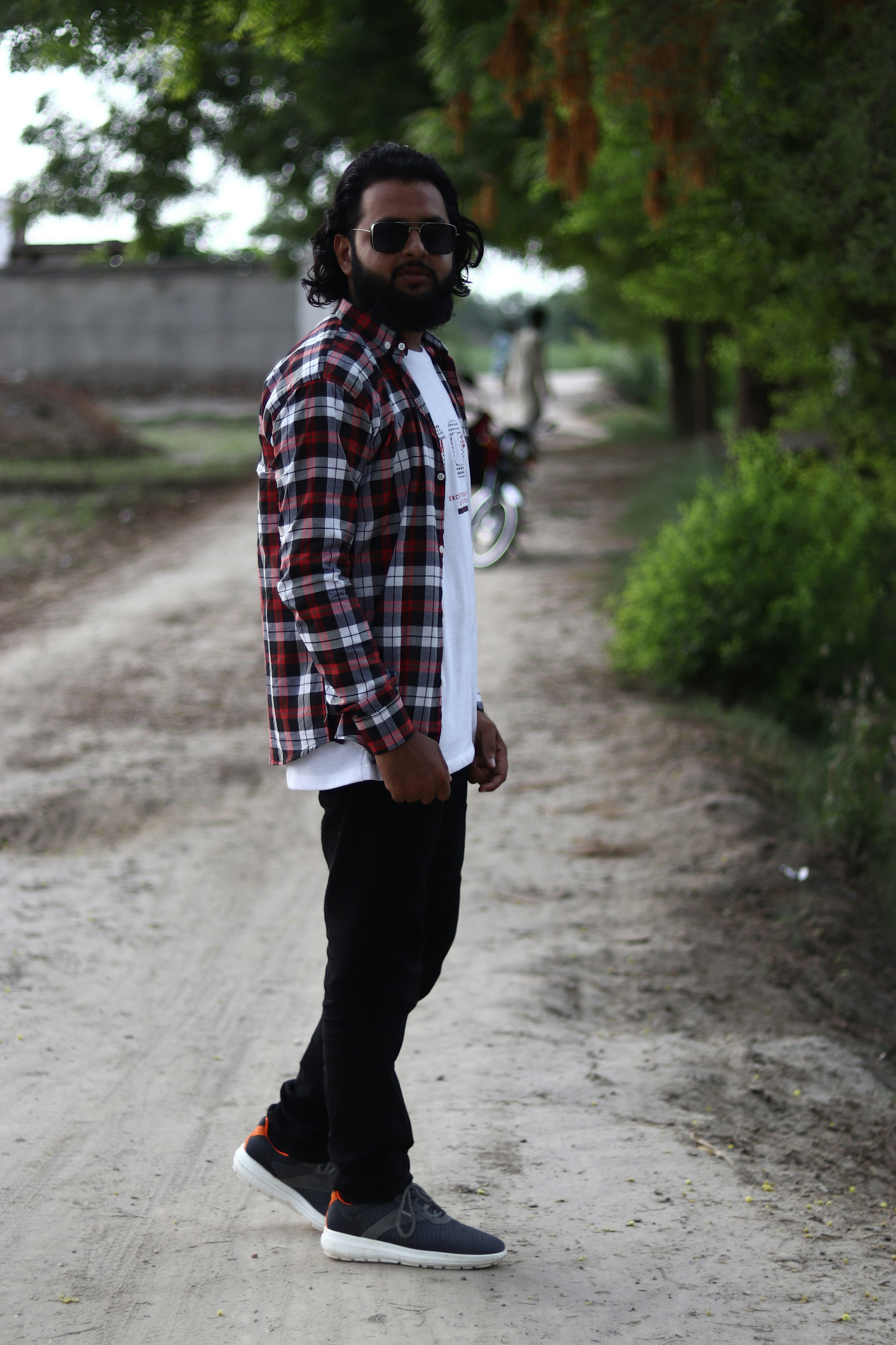 A man with a beard standing on a dirt road photo – Free Person Image on ...