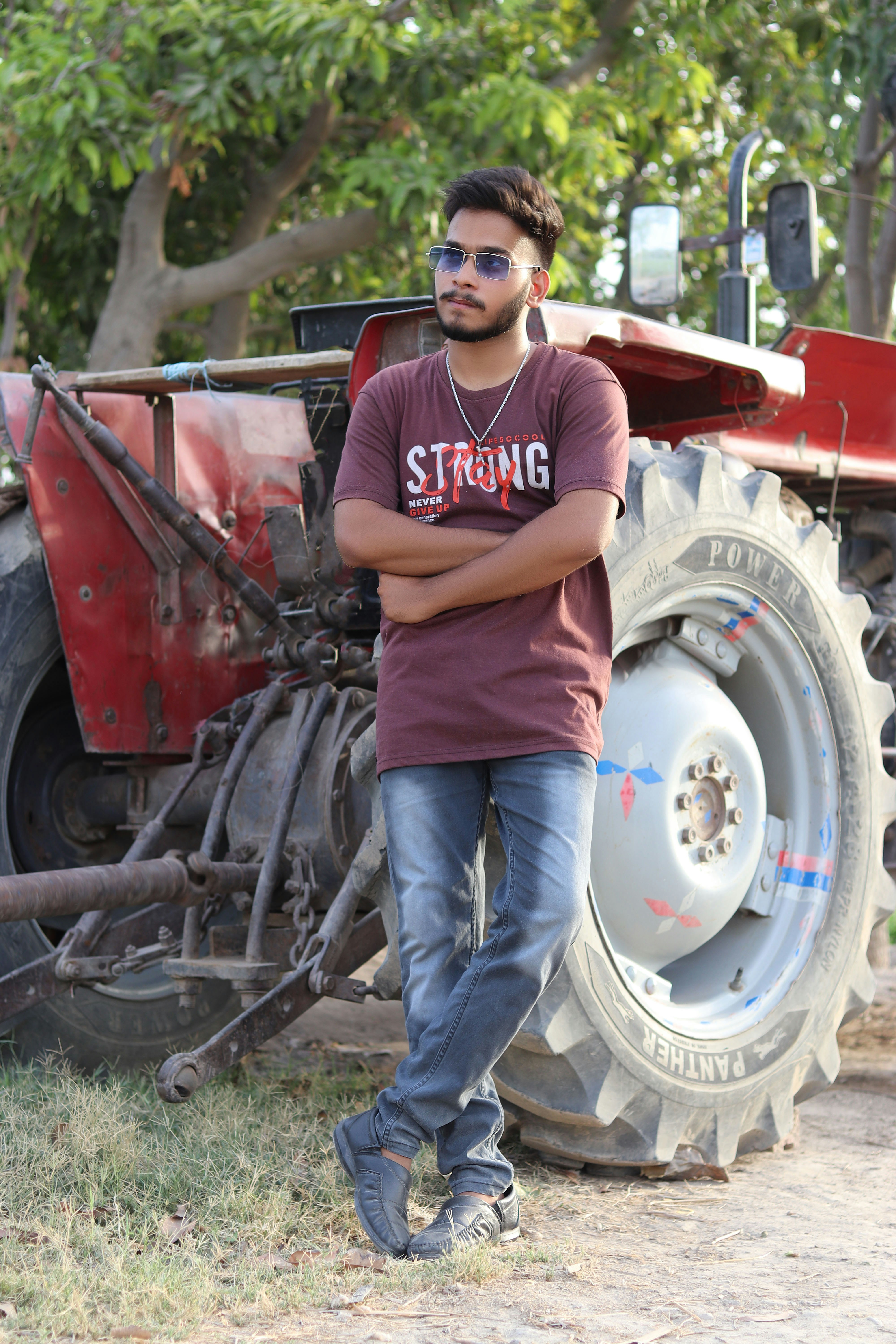 Steel and Sun: A Quiet Portrait by a Red Tractor