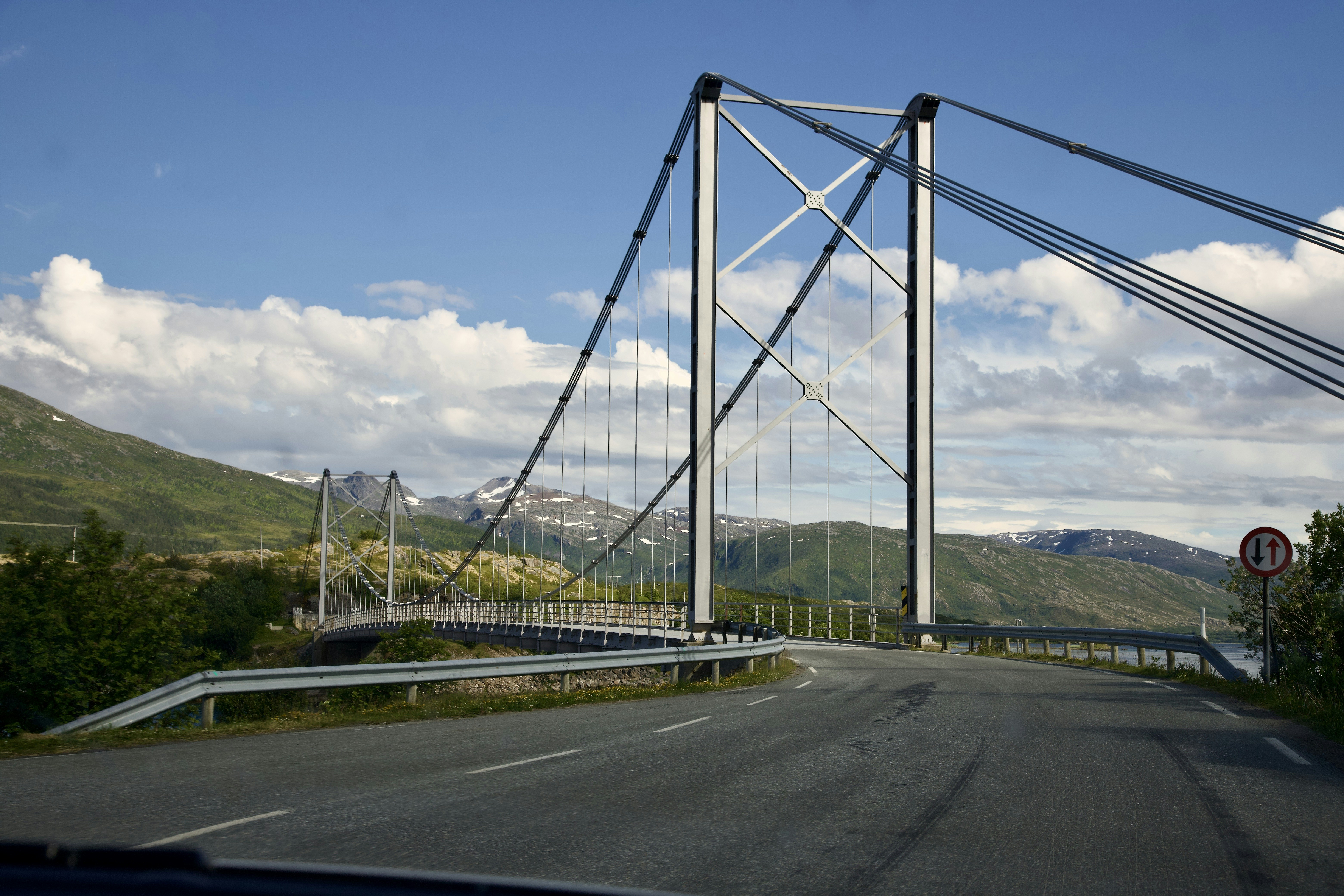 Bridge Over a Curving Highway Under a Bright Nordic Sky