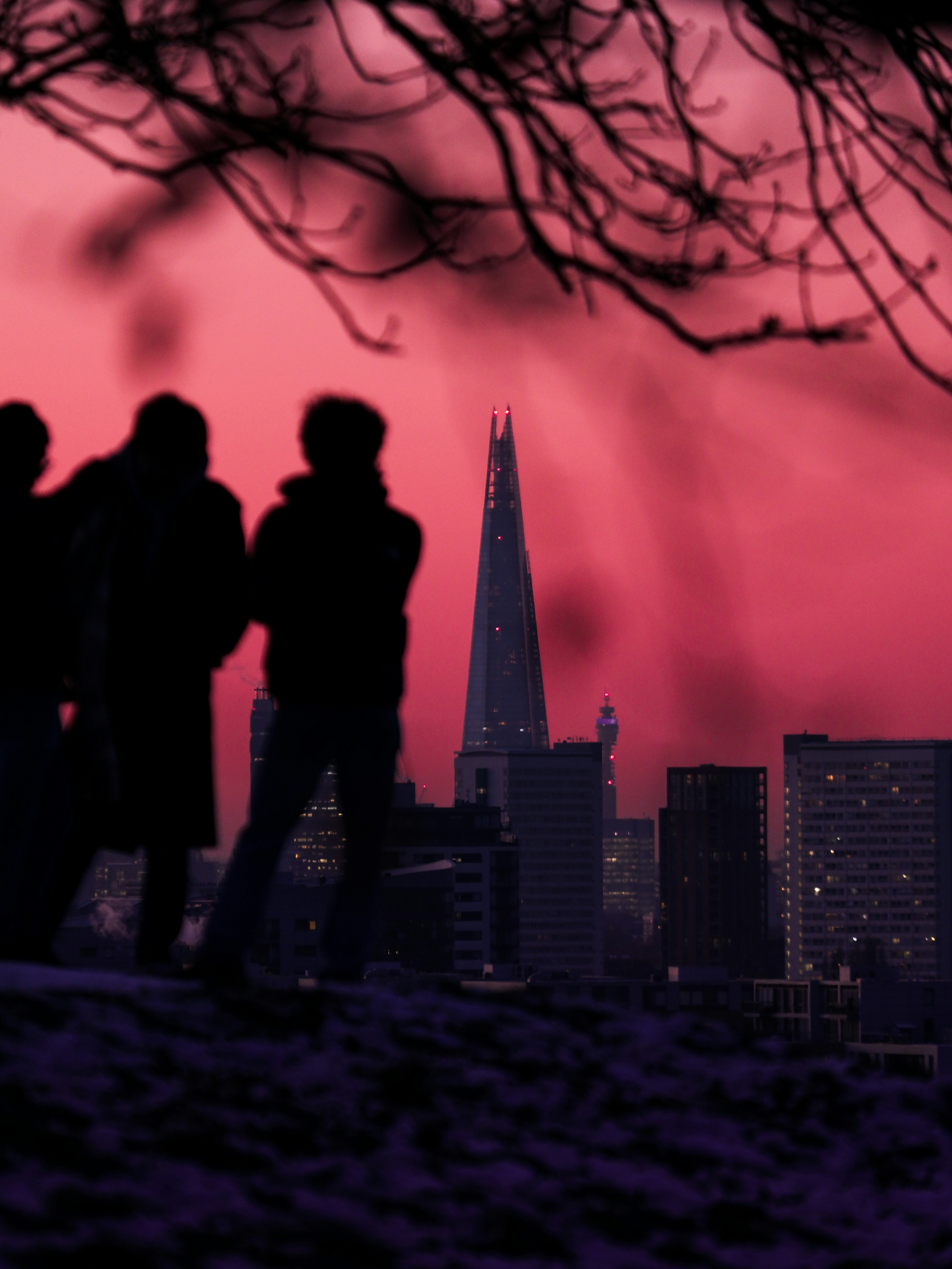 Rising City Spire Framed by Silent Silhouettes