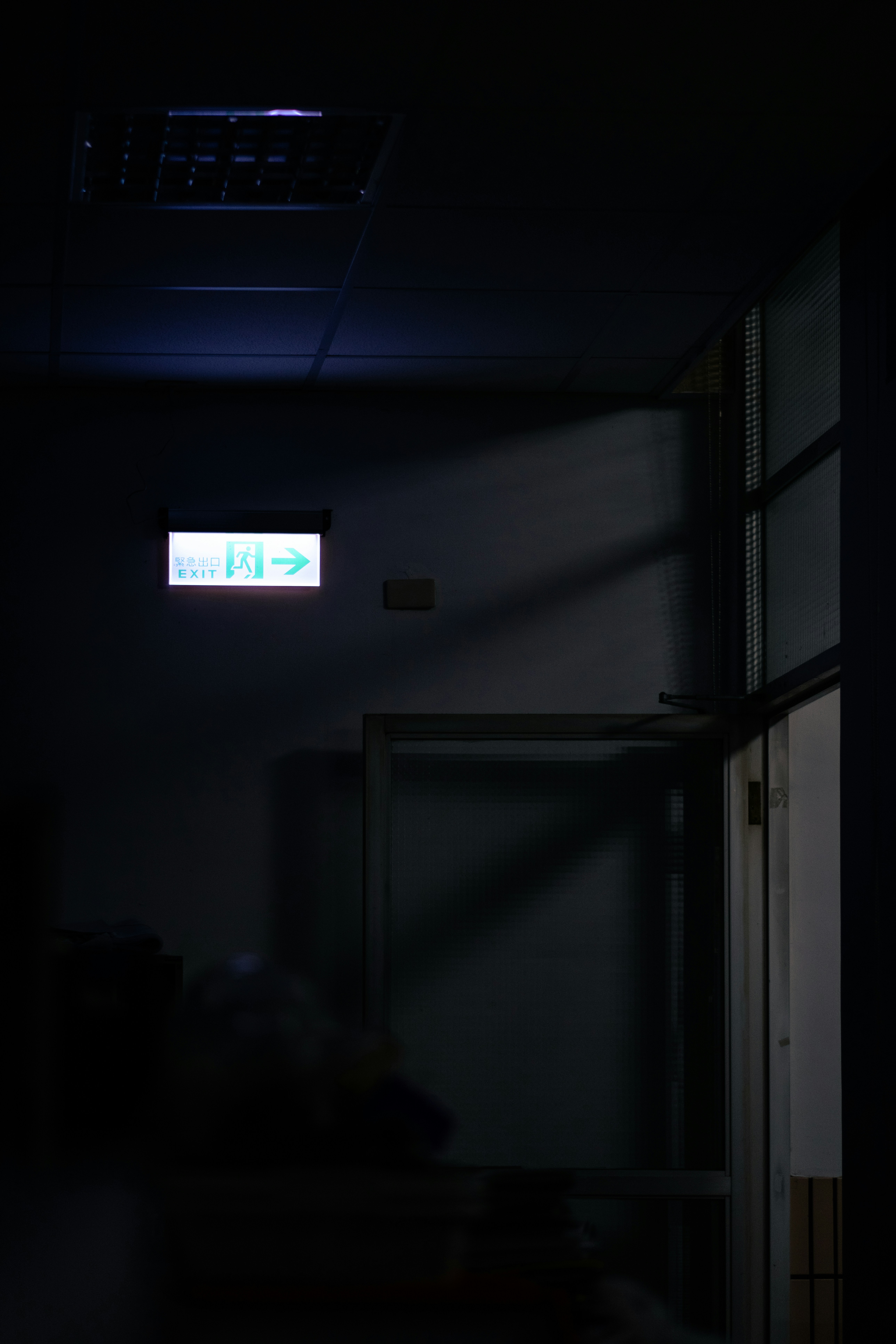 a dark room with a sign that says exit