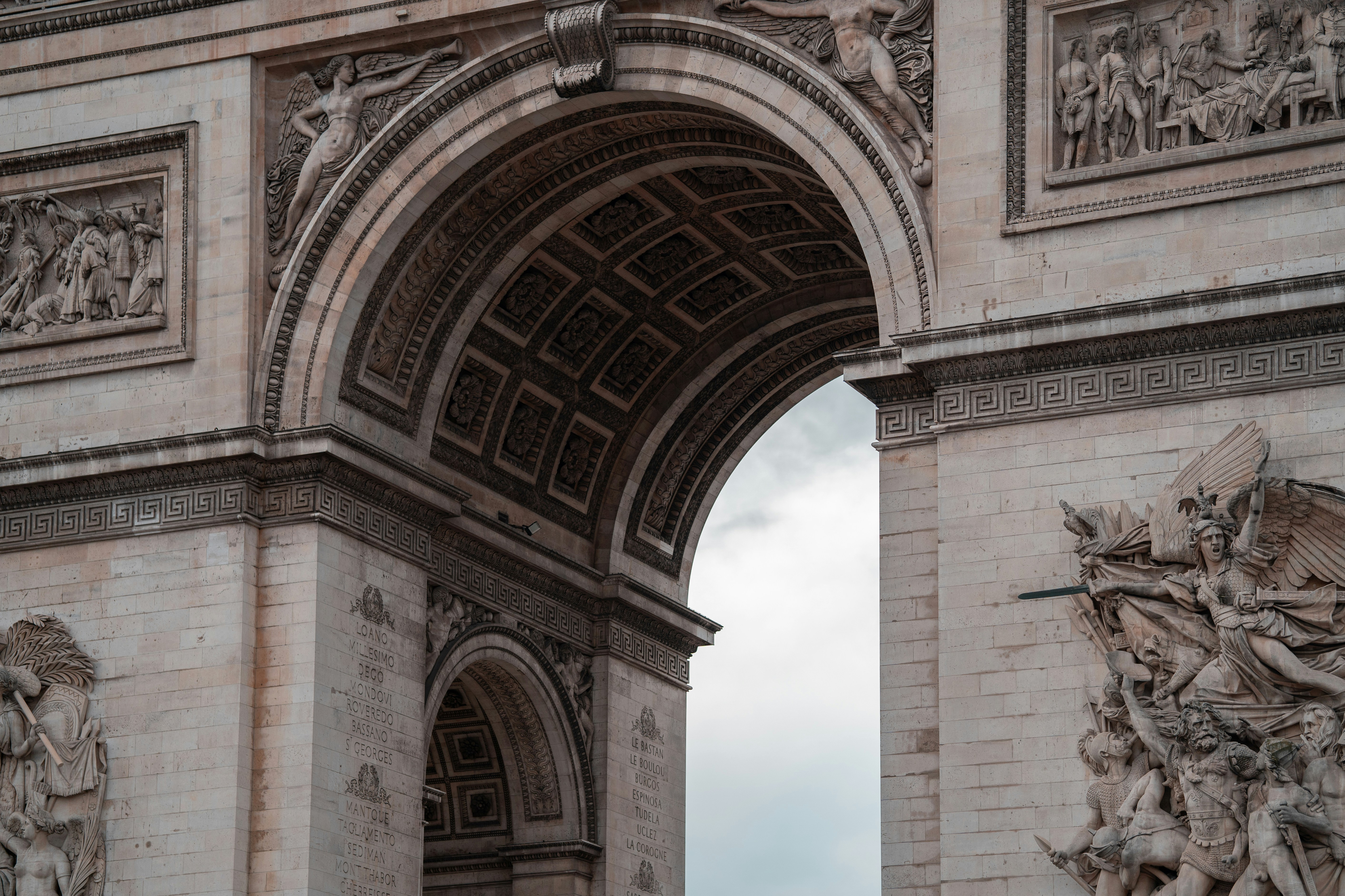 A stone arch with statues on the sides of it photo – Free Paris Image ...