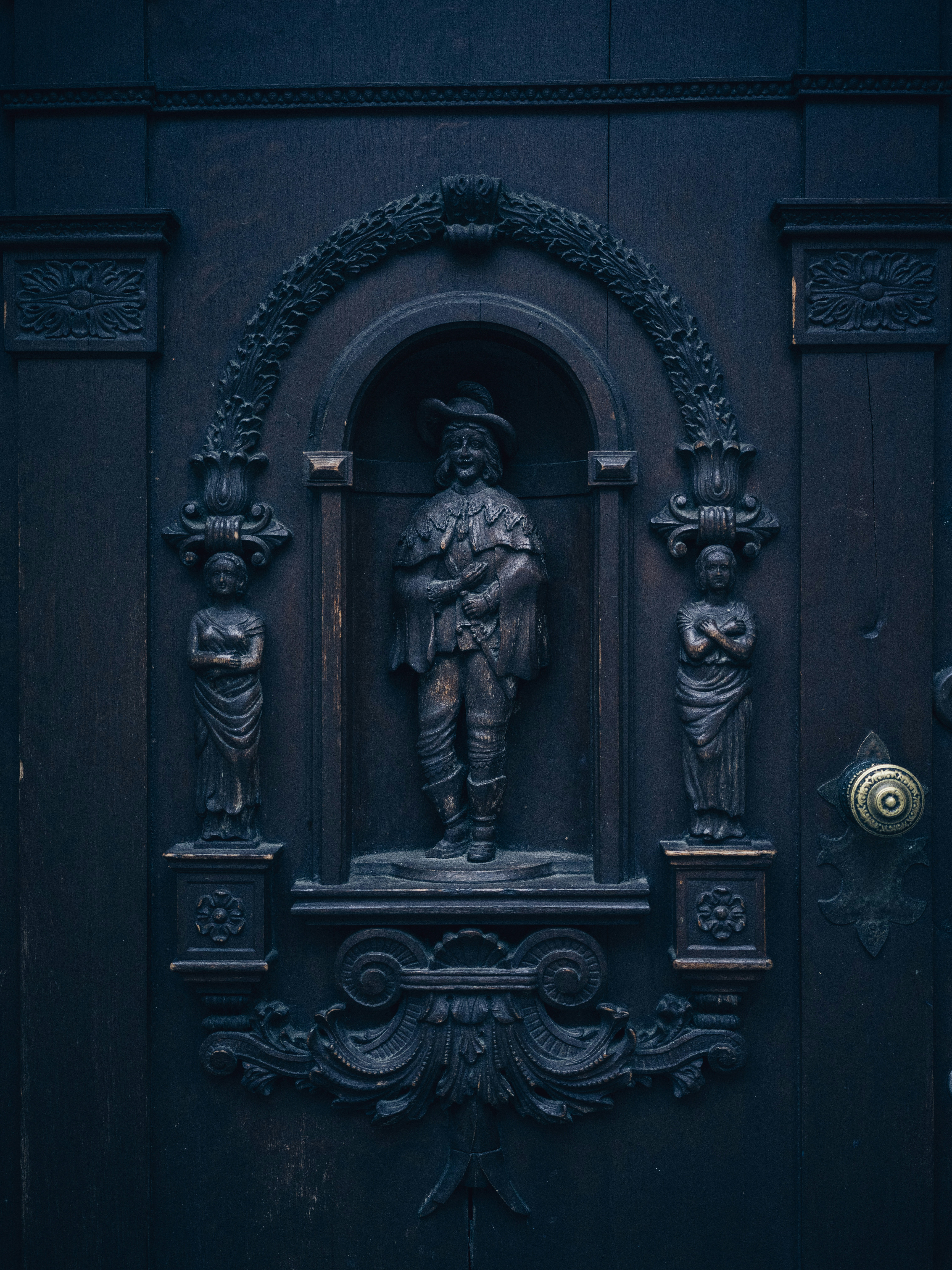 Nocturnal Guardian: Central Statue Framed by Ornate Doorway
