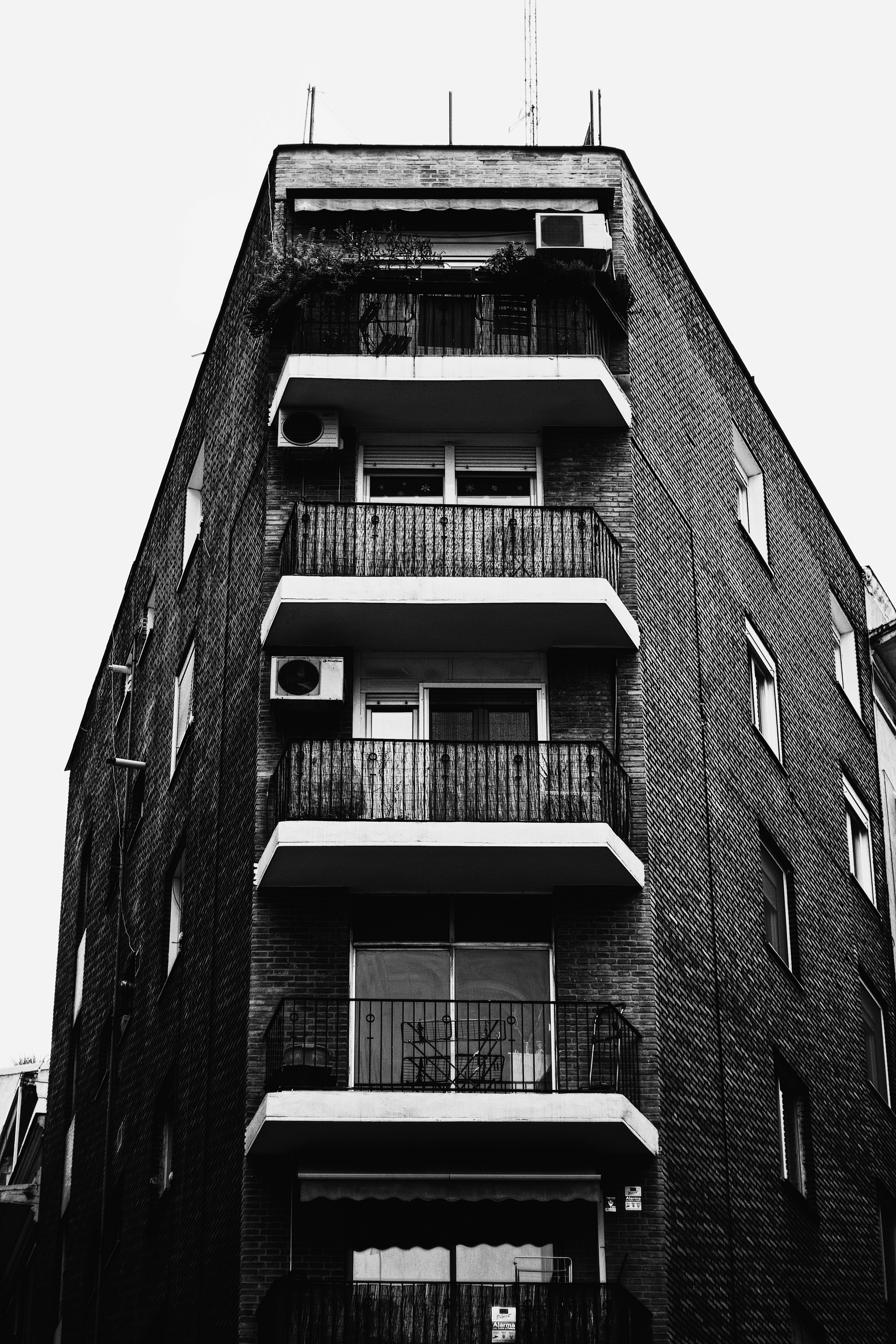 A tall brick building with balconies and balconies photo – Free City ...
