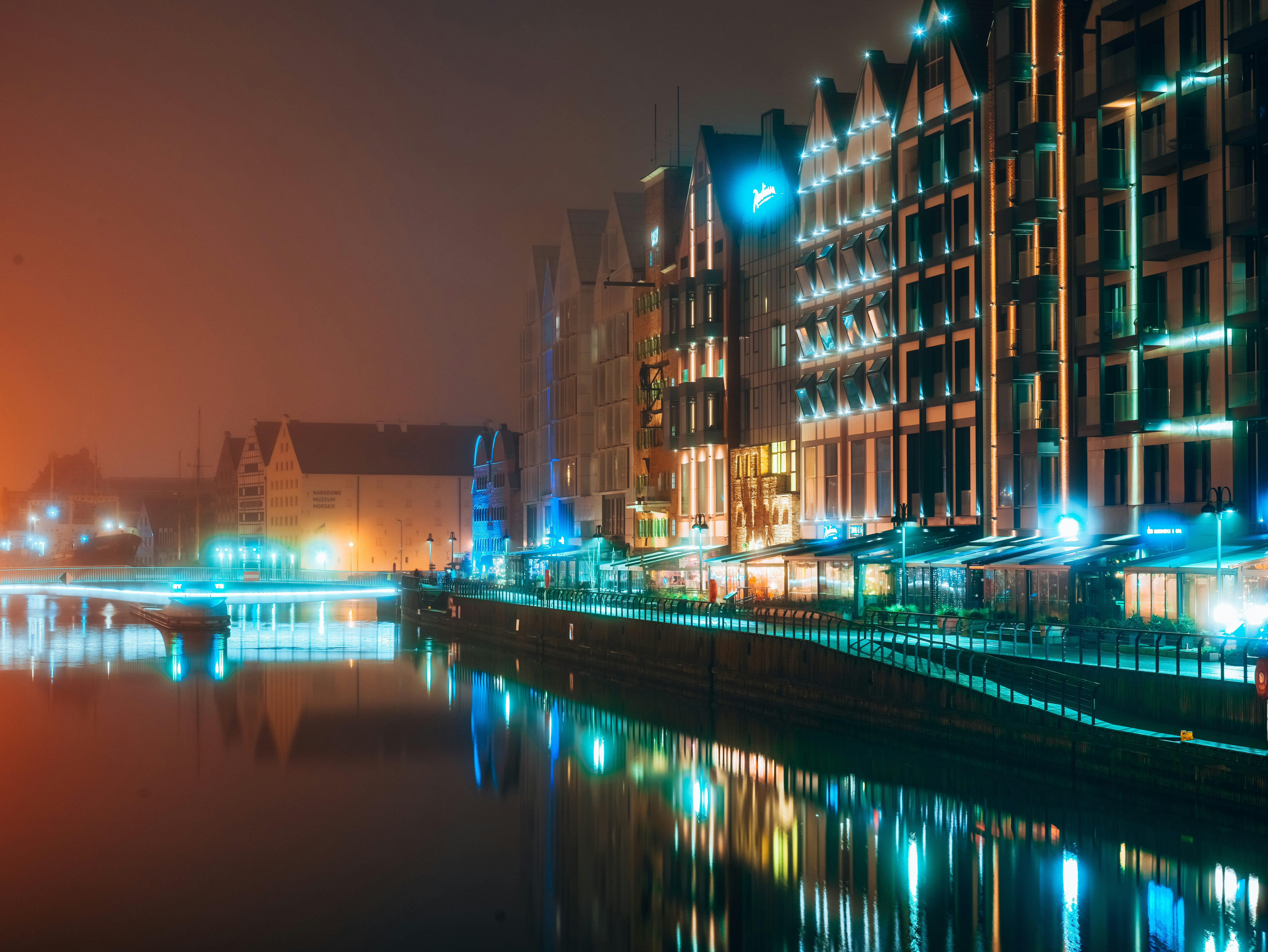 A city at night with lights reflecting in the water photo – Free Night ...