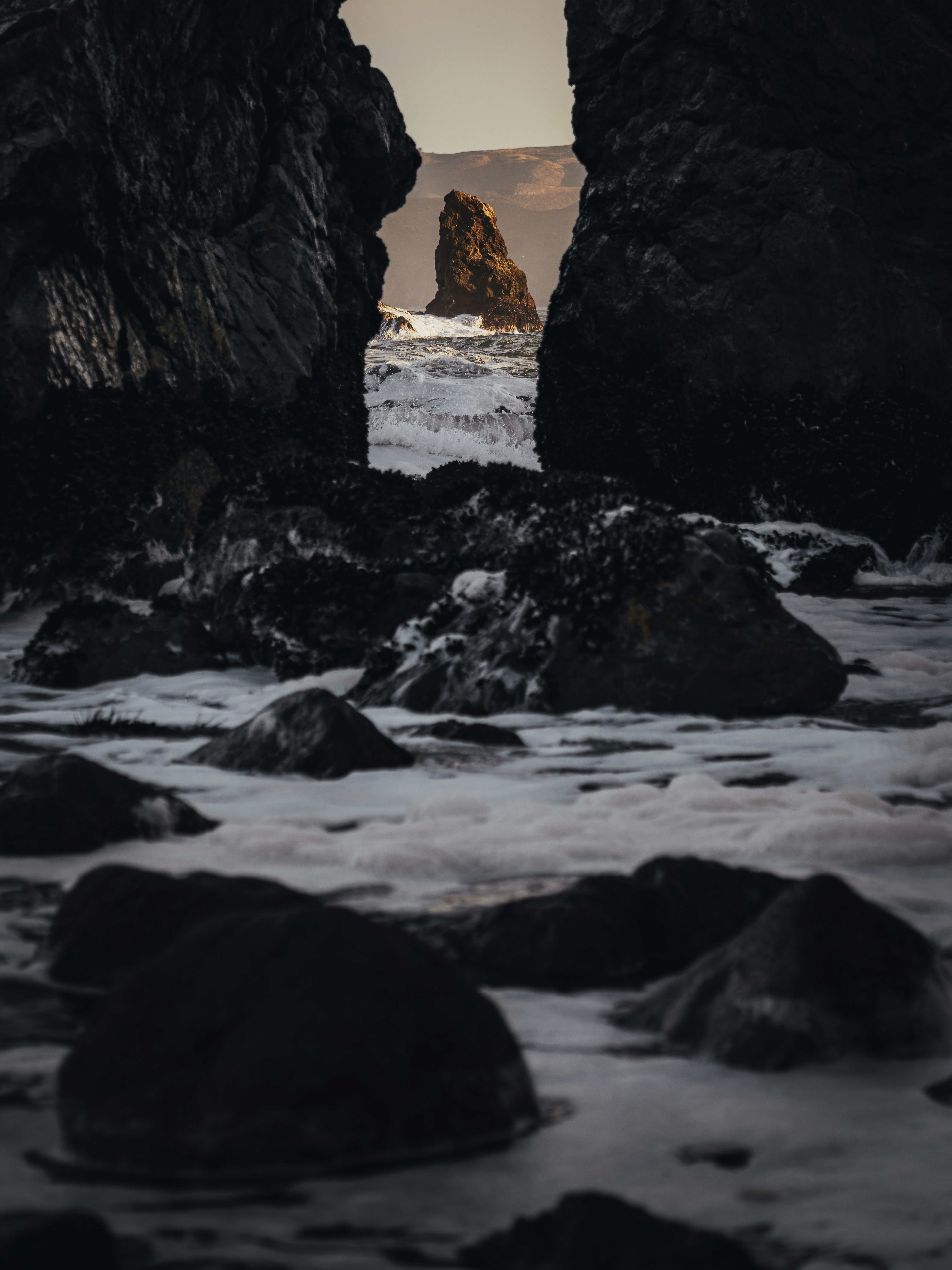 A view of the ocean through some rocks photo – Free San francisco Image ...