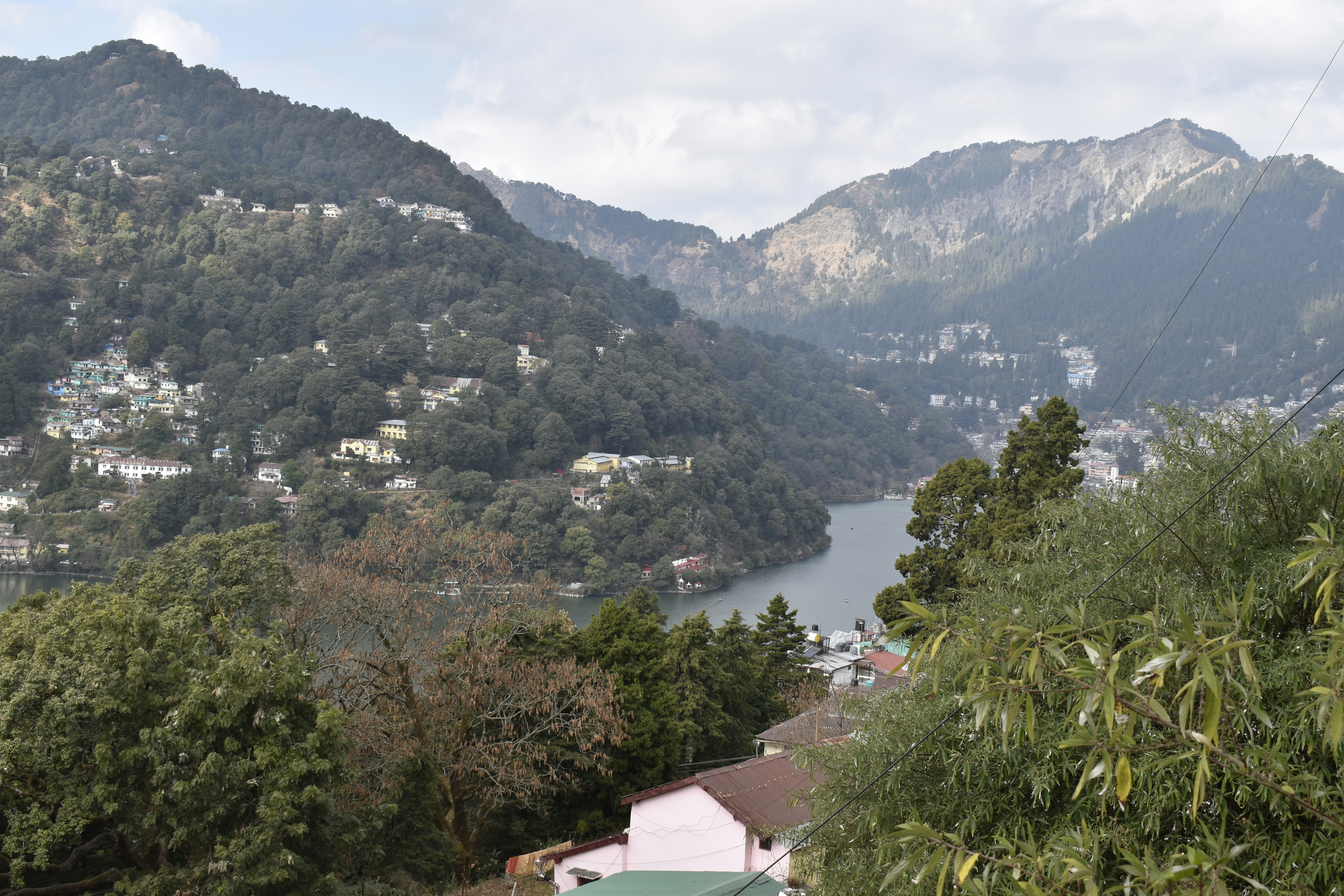 Valley Mirror: Lake Nestled Between Forested Slopes and Distant Peaks