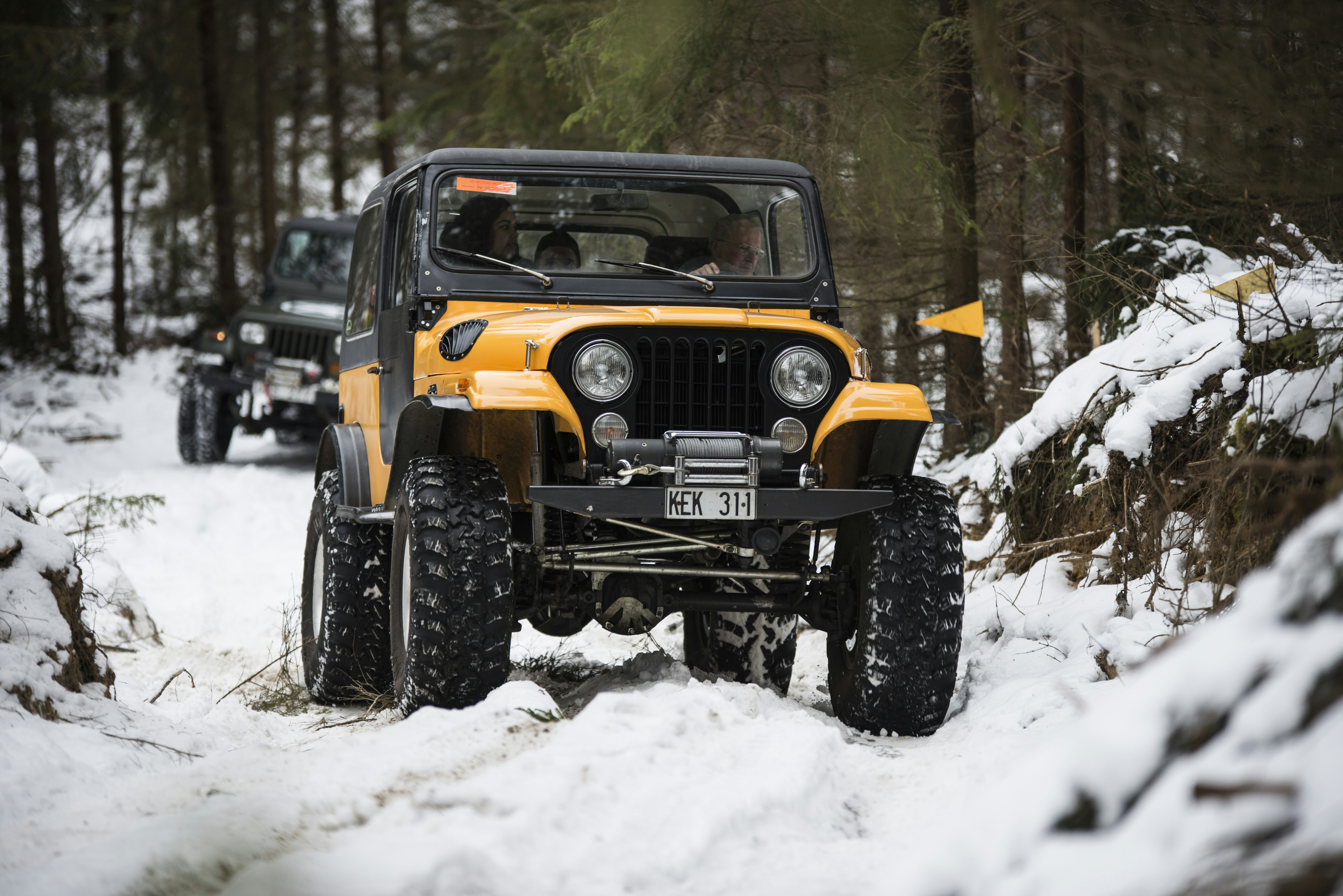 A jeep driving through the snow in the woods photo – Free Sweden Image ...