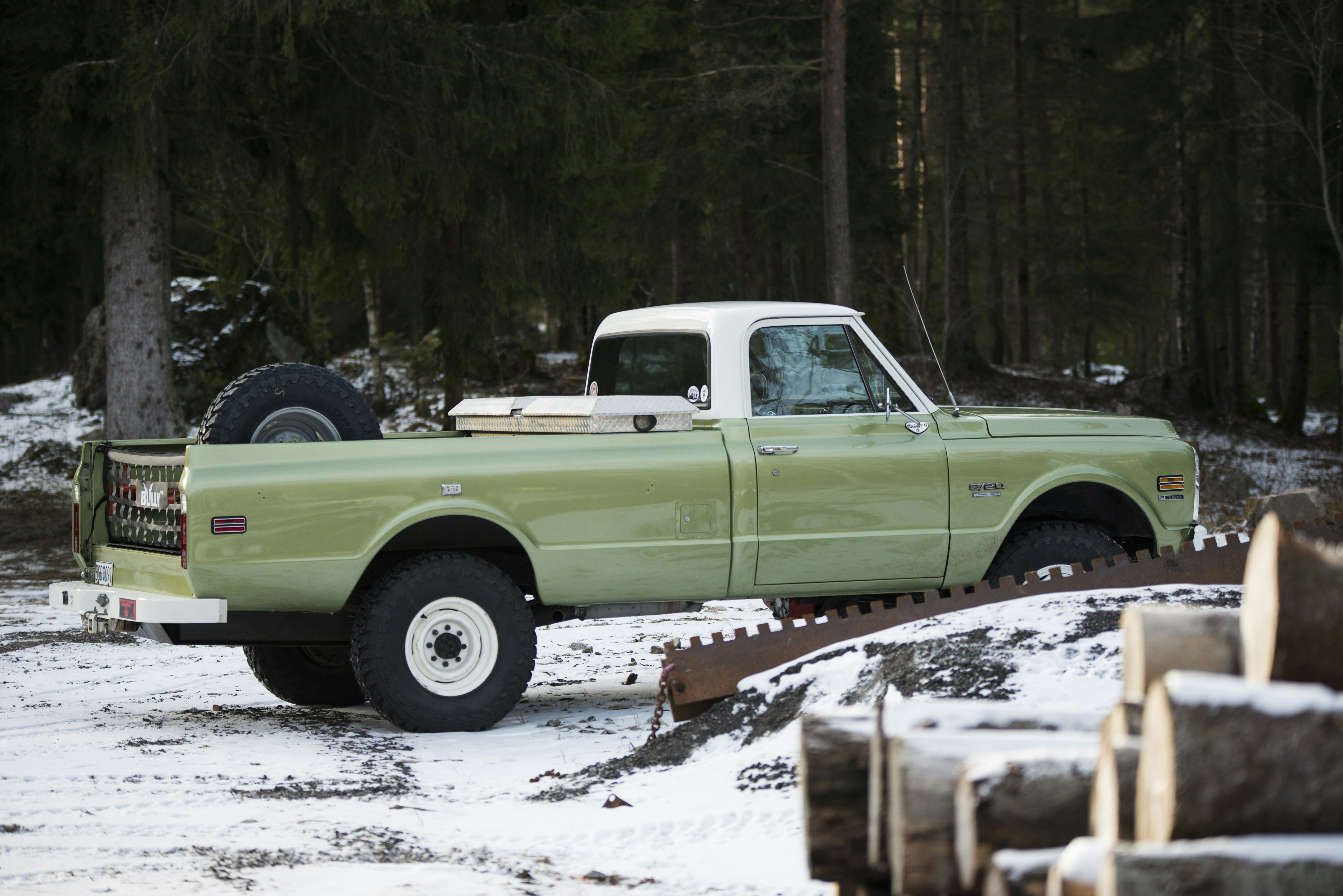 A green pick up truck parked in the snow photo – Free Truck Image on ...