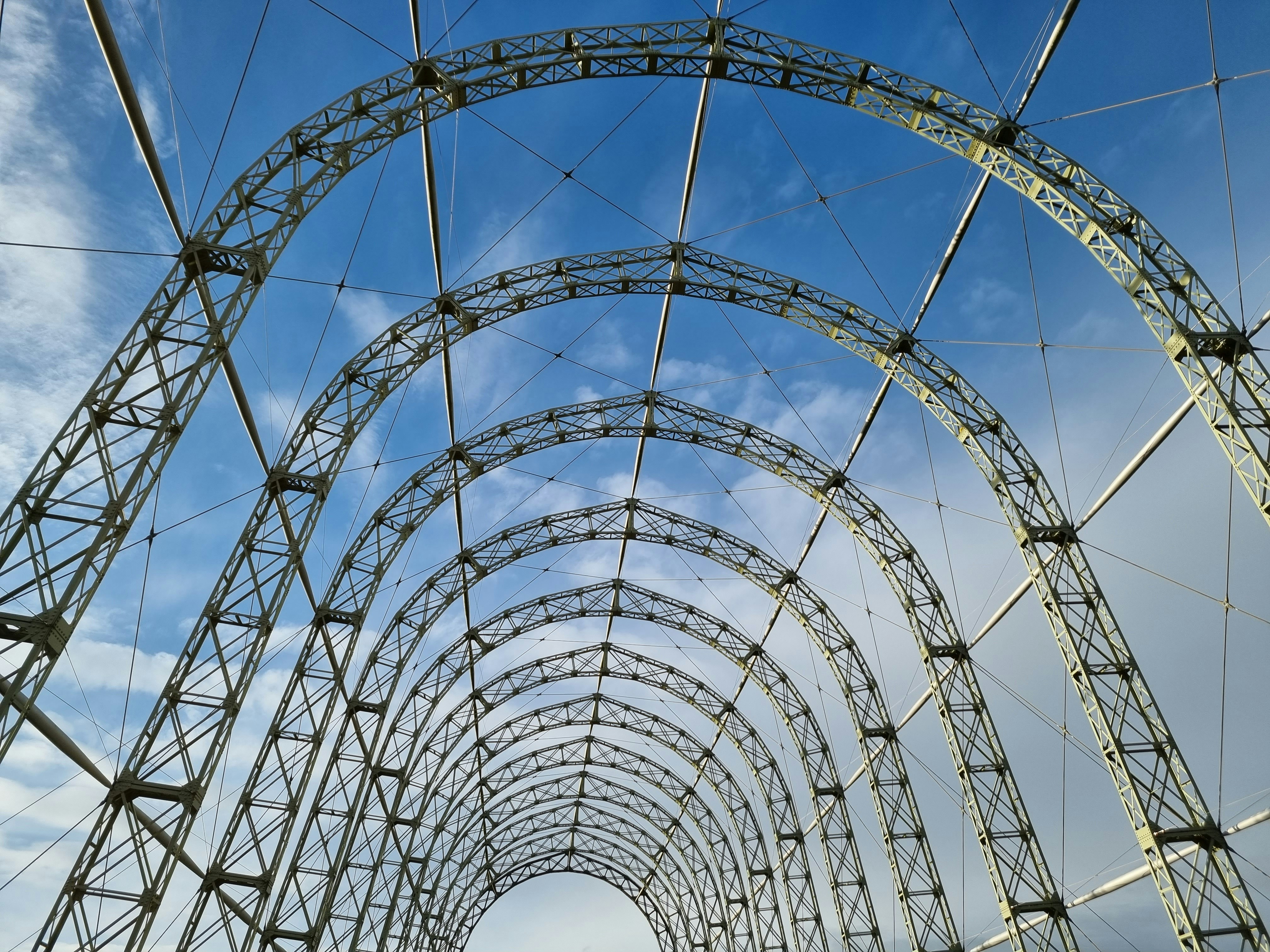 A very tall metal structure with a sky in the background photo – Free ...