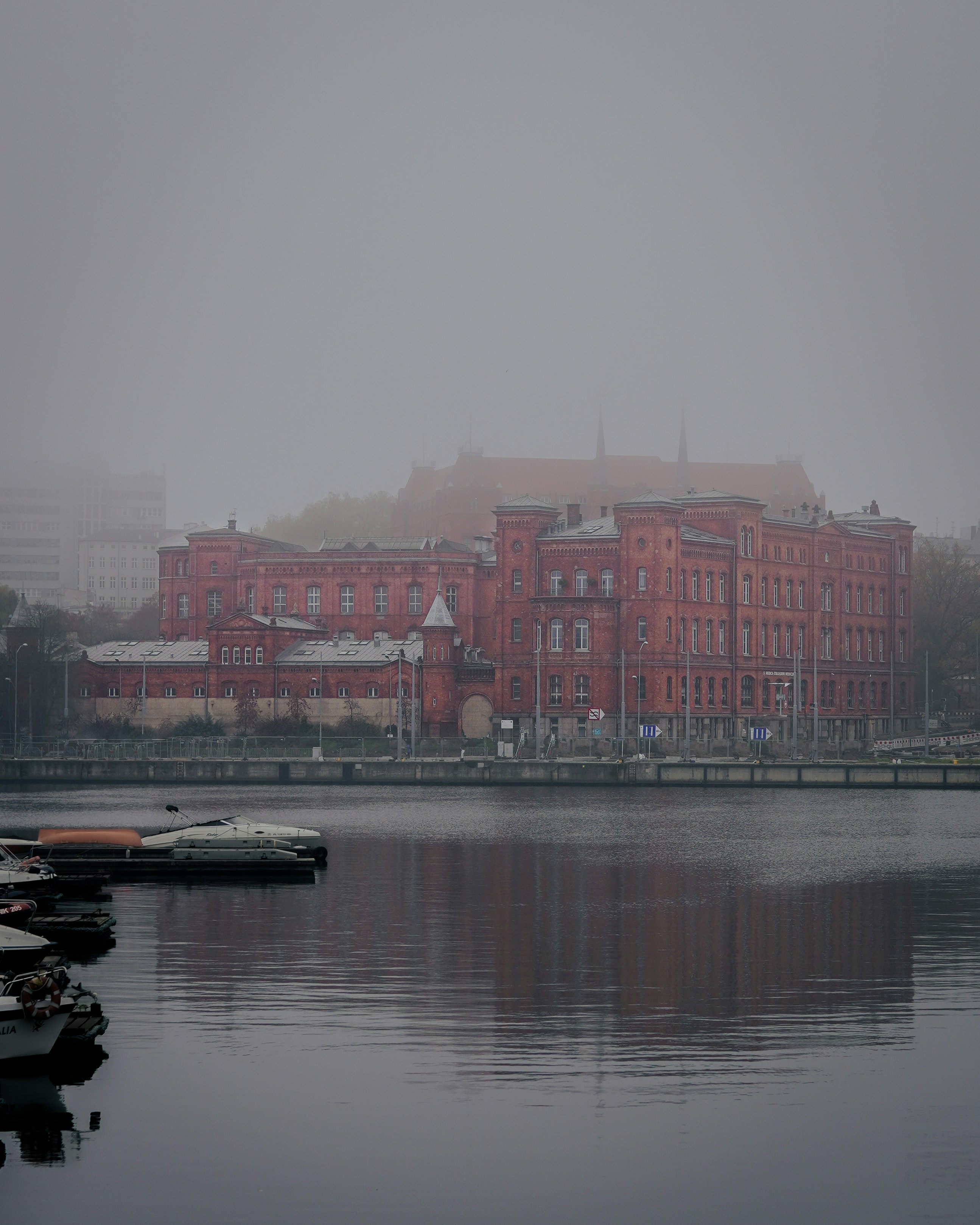Fogbound Harborfront: Red Brick Complex Emerging From the Mist